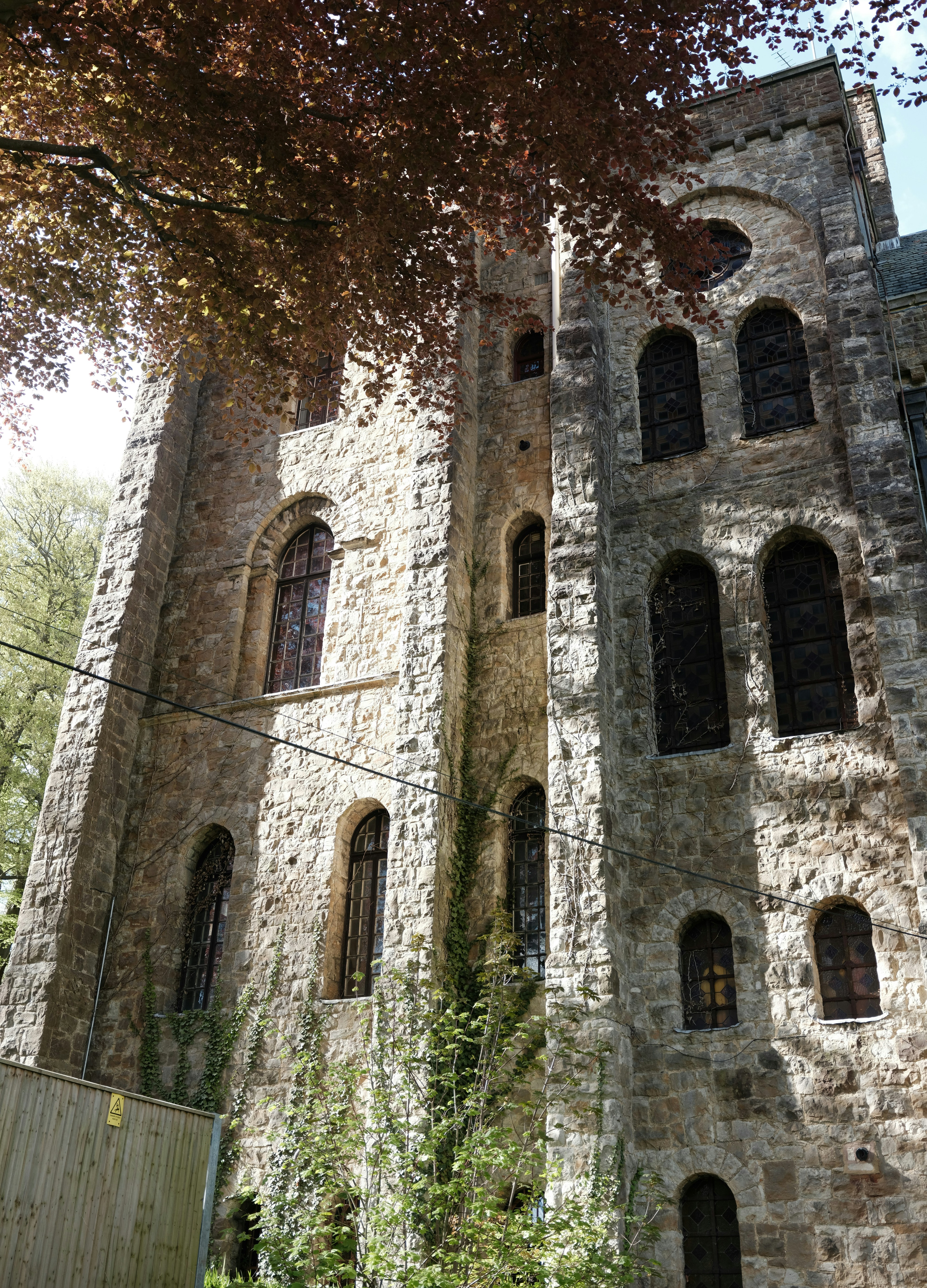 Stone Towered Facade Framed by Autumn Canopy