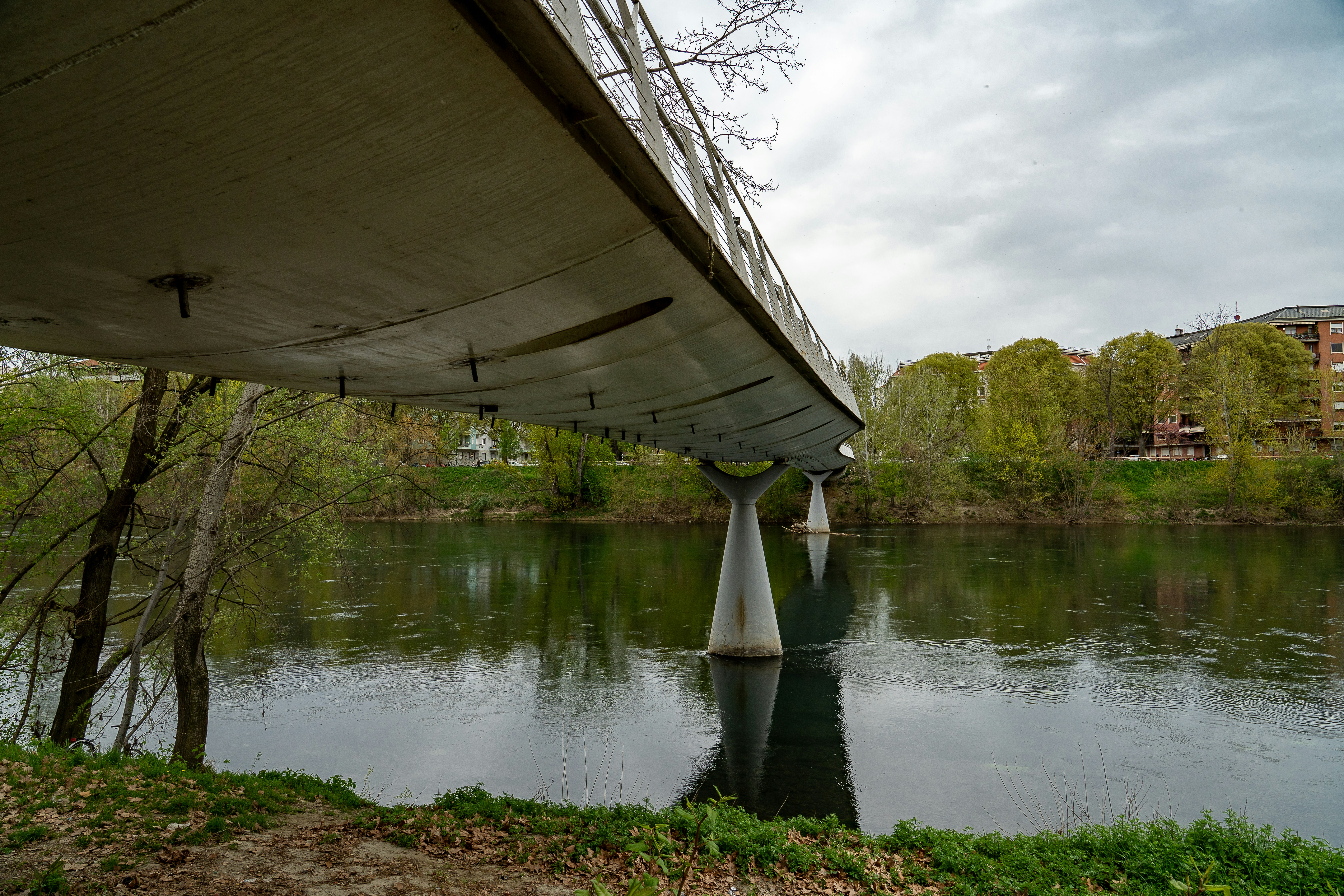 Under the Arch: A River Crossing under a Quiet Bridge