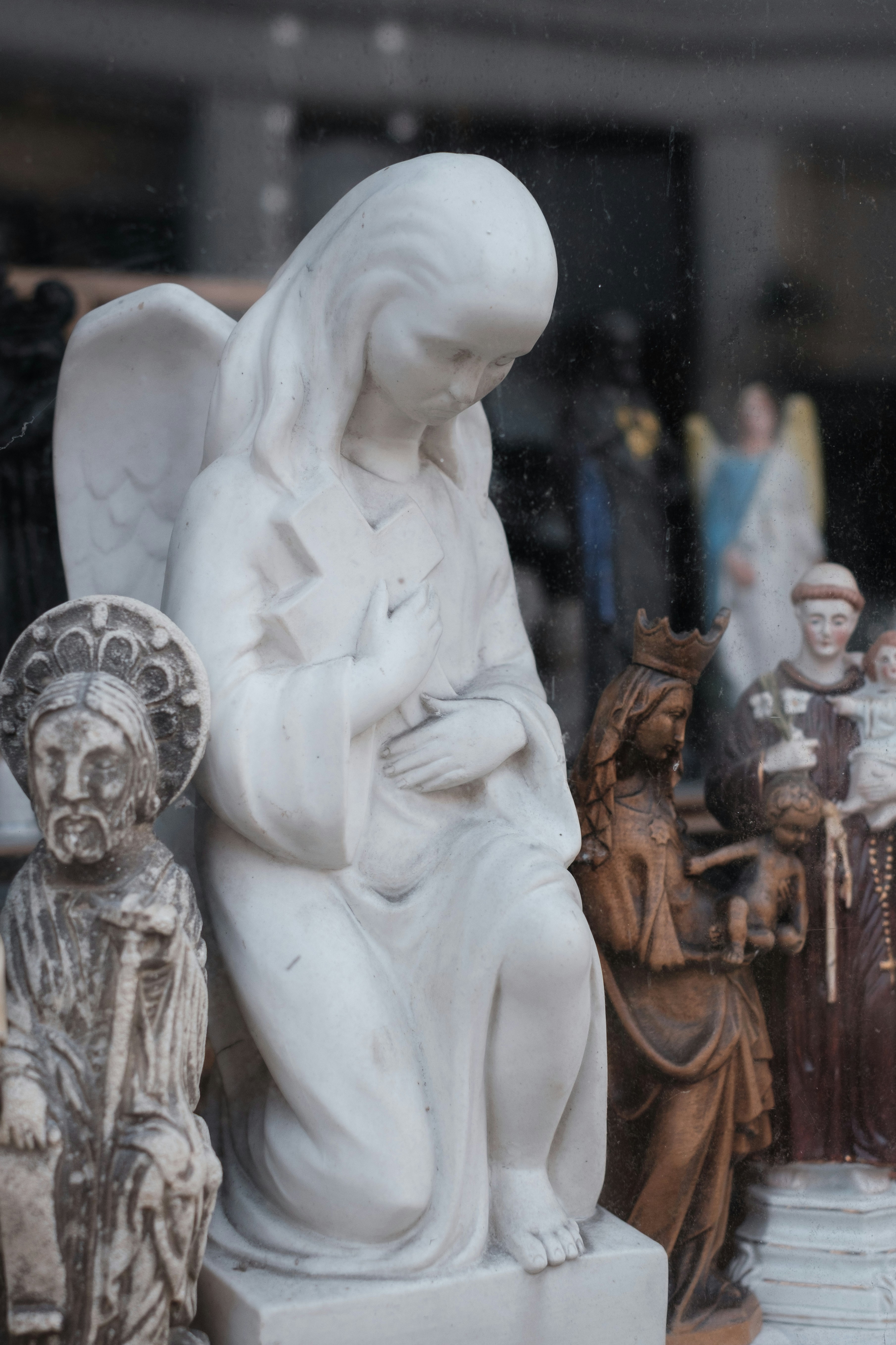 Silent Angel among Miniatures: Reverent Curios in a Glass Display