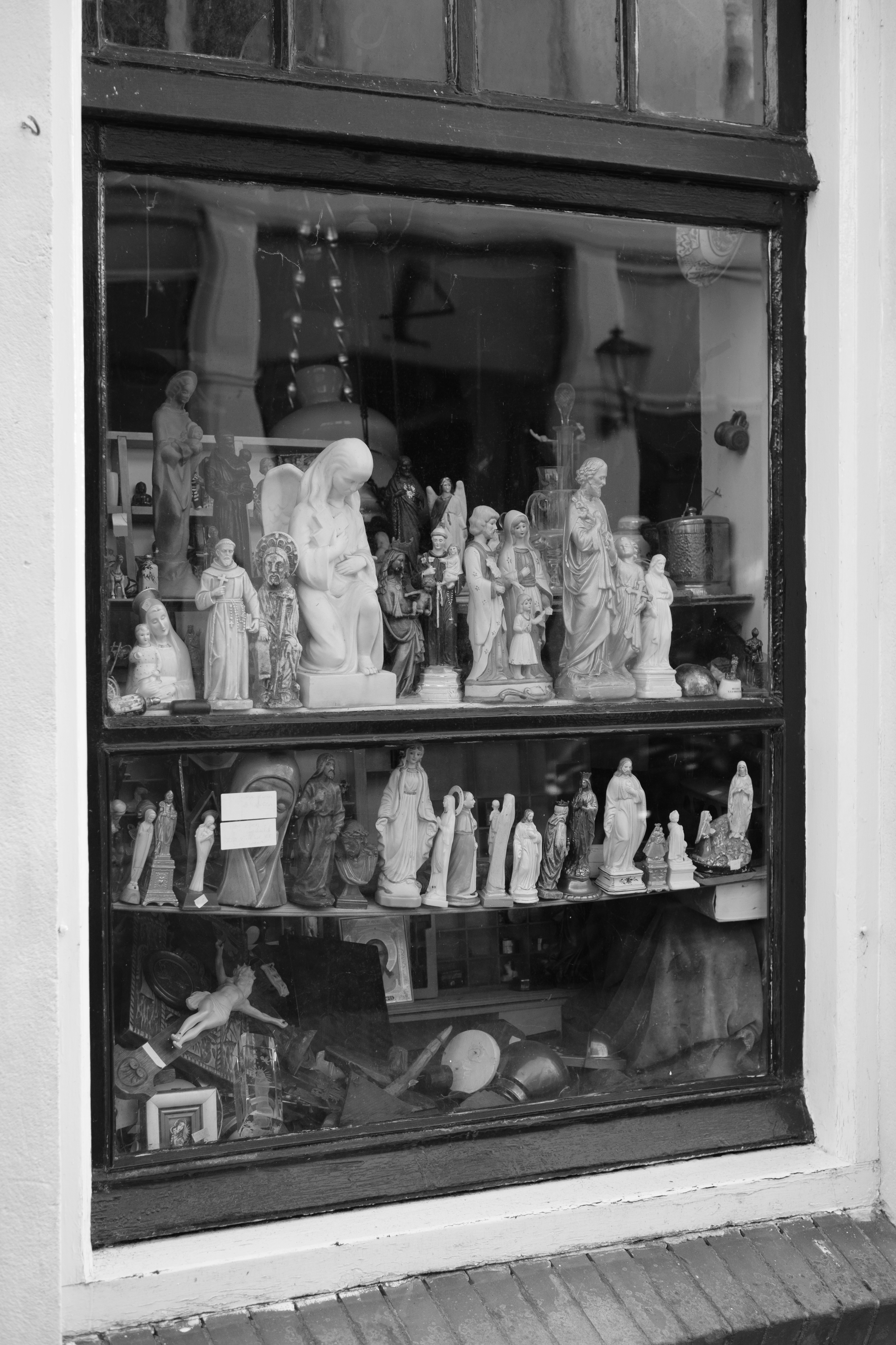Statuary Window Still Life: A Quiet Gallery of Figures in Glass
