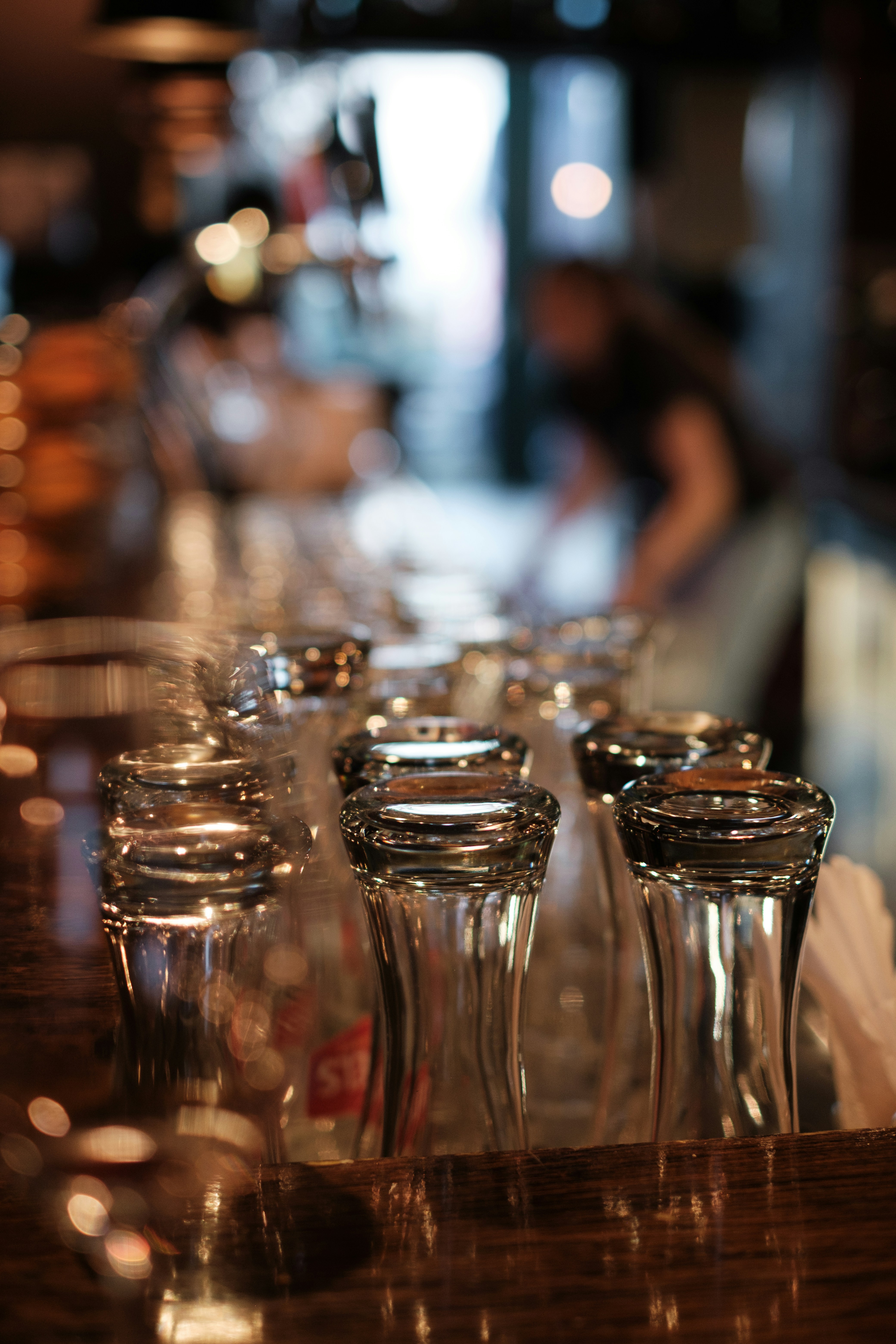 Blurred Bar Blues: Glasses Recede into a Warm, Quiet Backroom