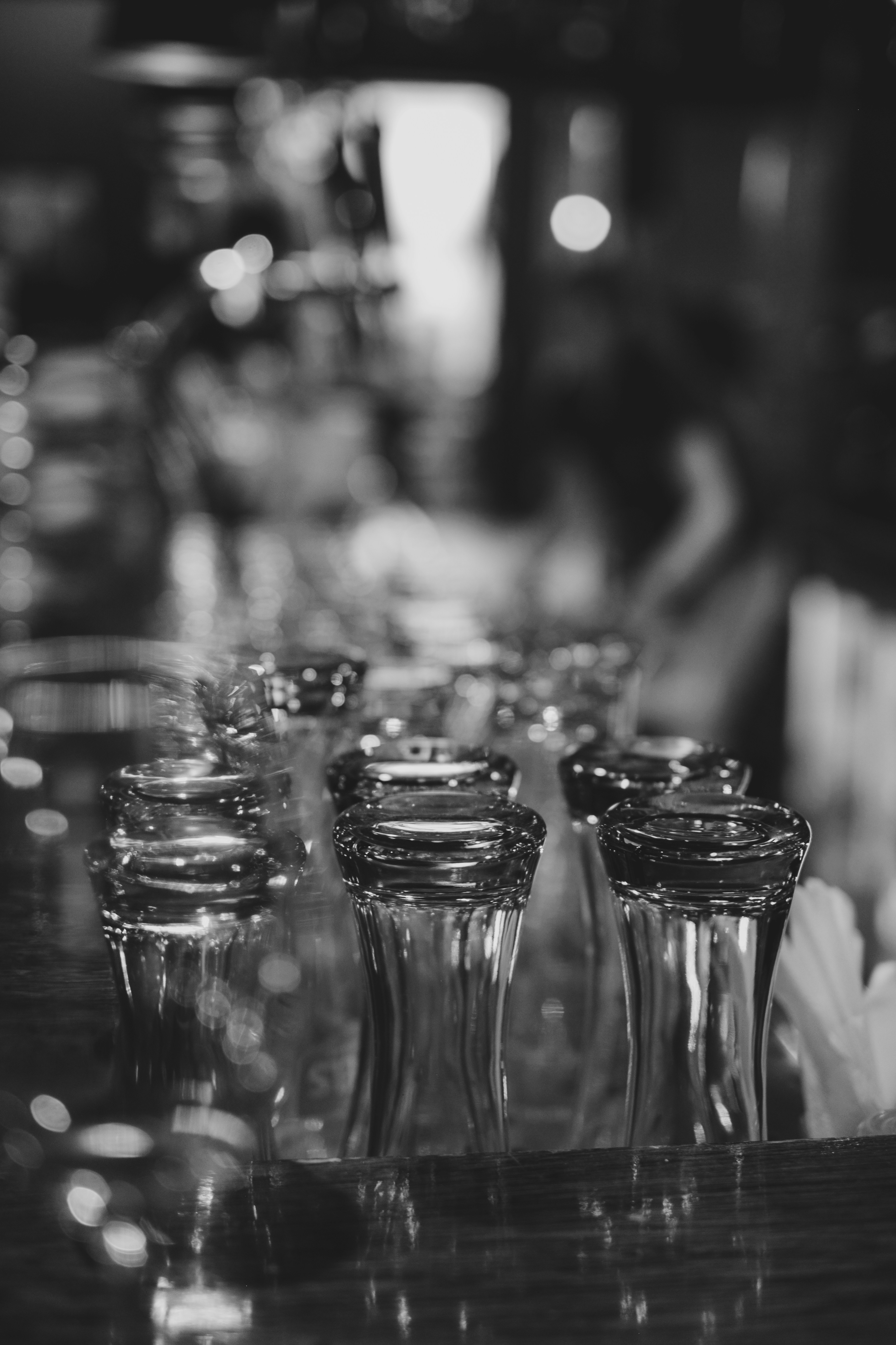 Row of Glass Tumblers on a Gleaming Bar