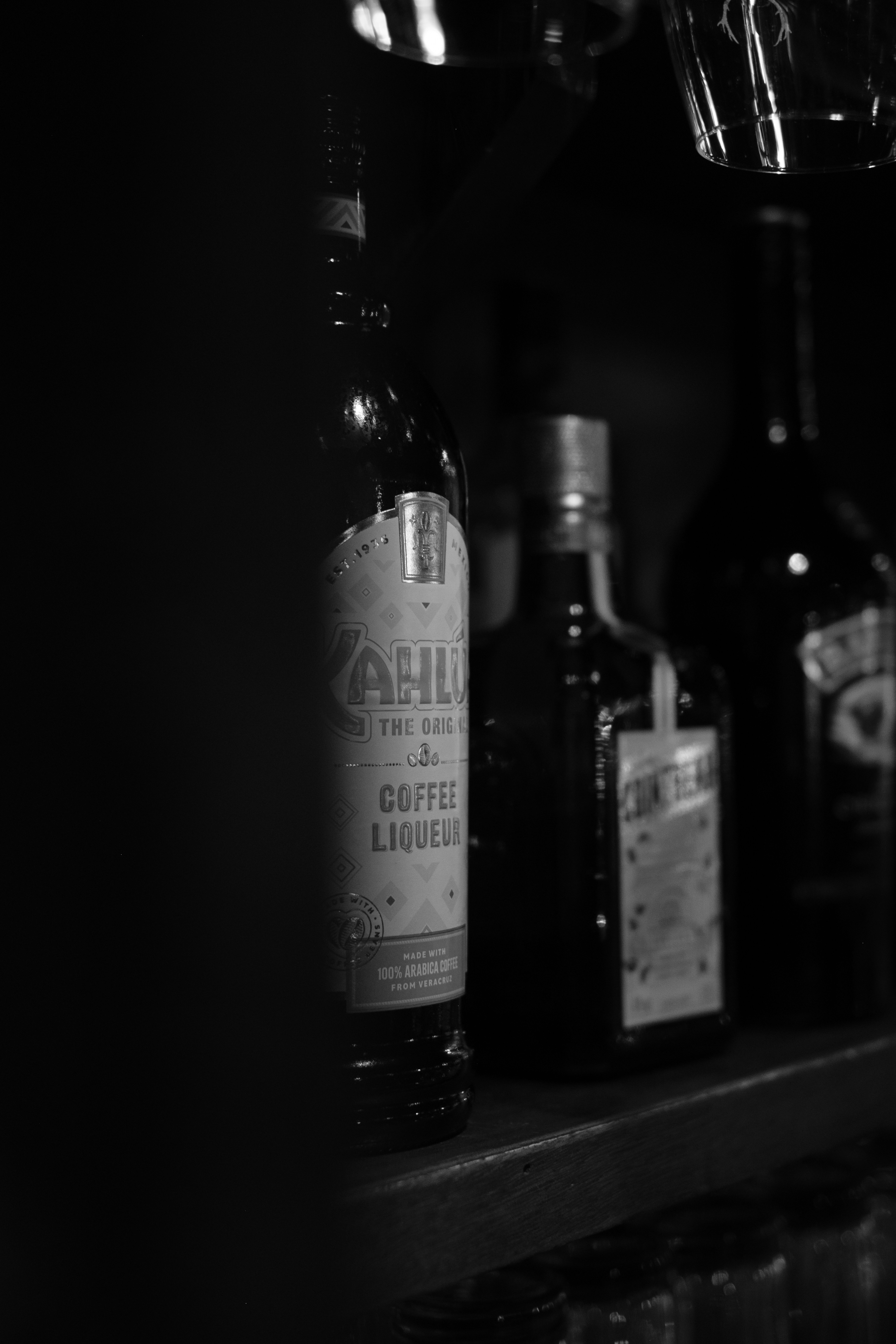 Dim Bottles in a Backlit Bar: A Quiet monochrome Still Life