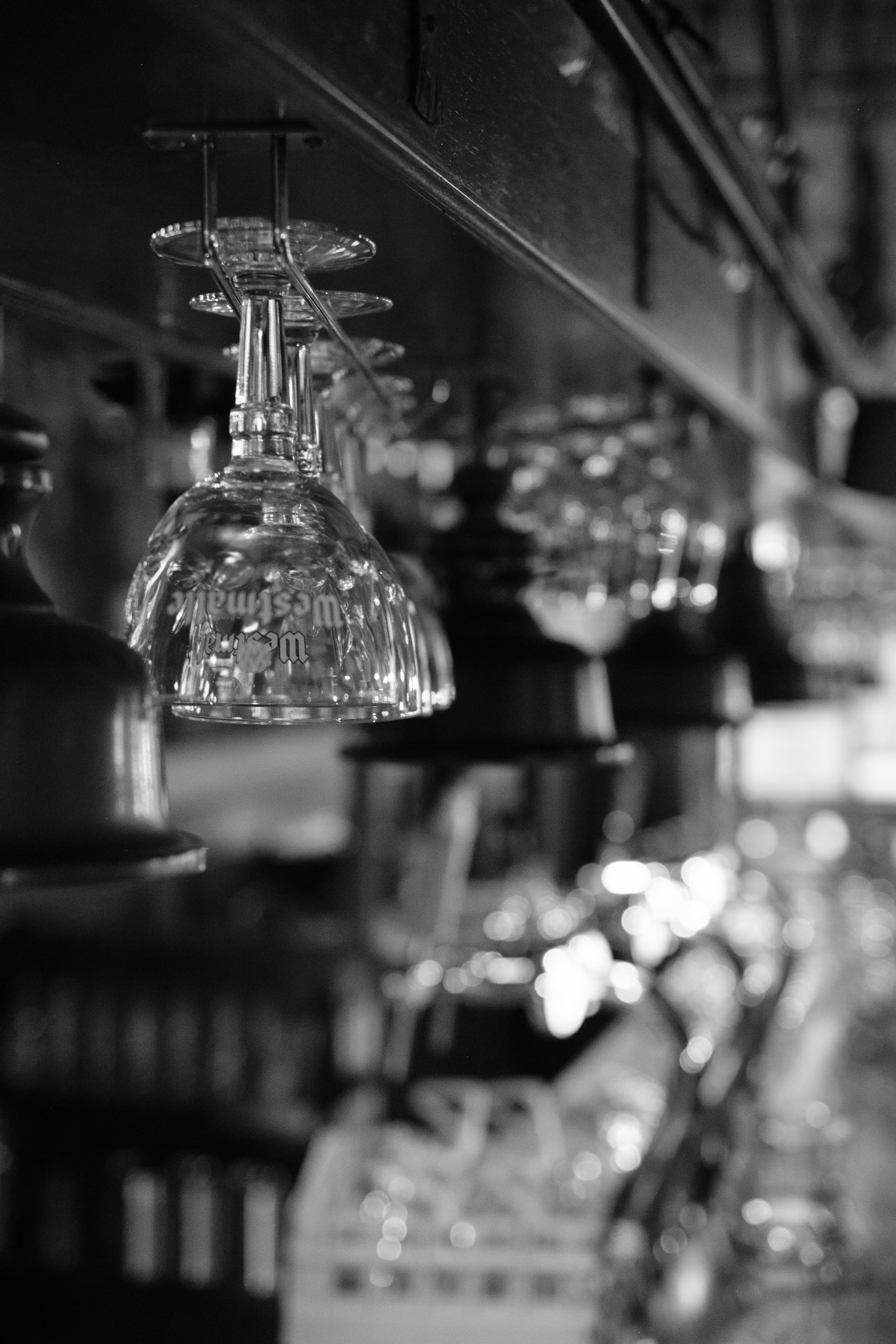 Hanging Glass: A Quiet Moment in the Bar's Glow