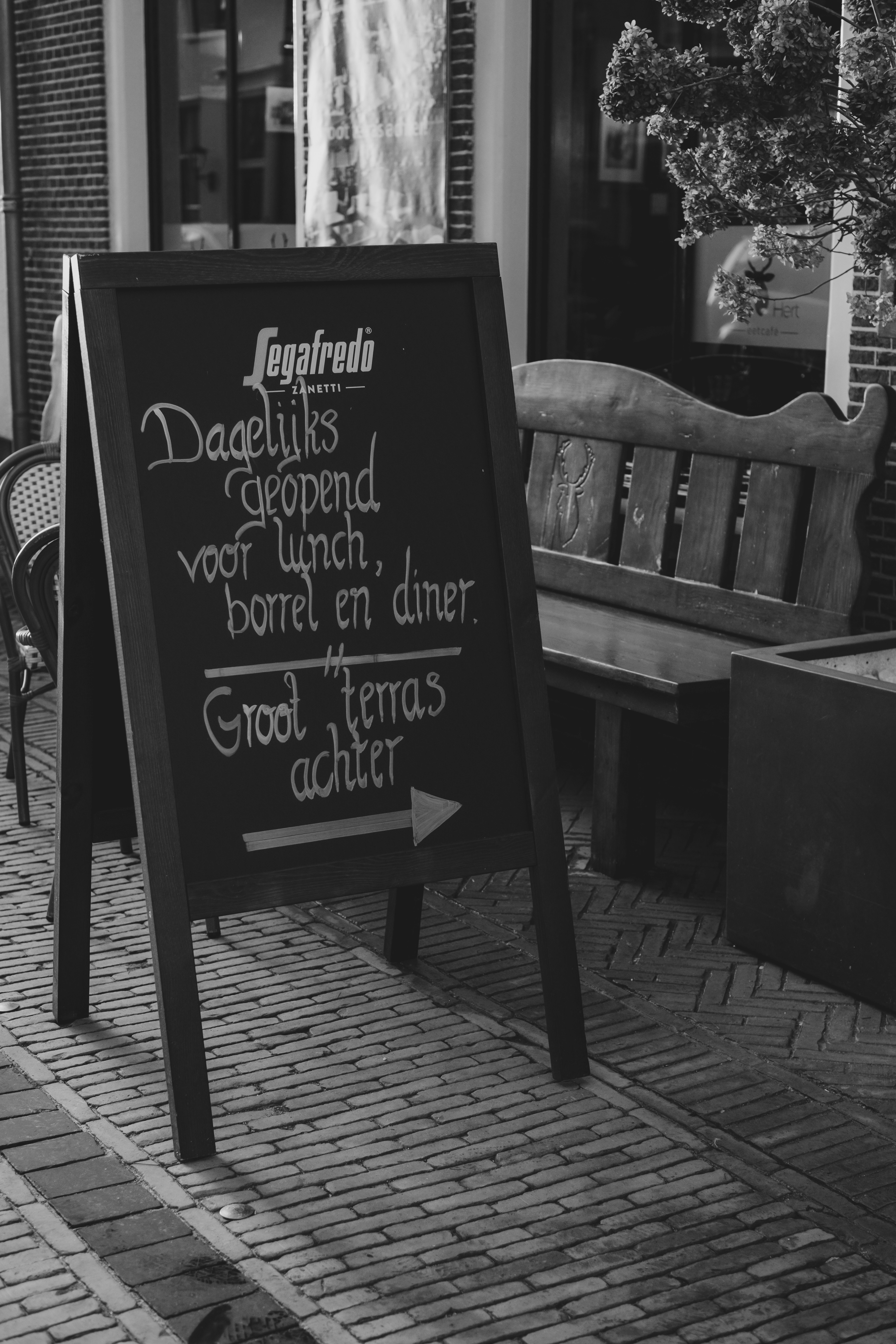 Whispering Chalkboard Sign in a Quiet European Courtyard