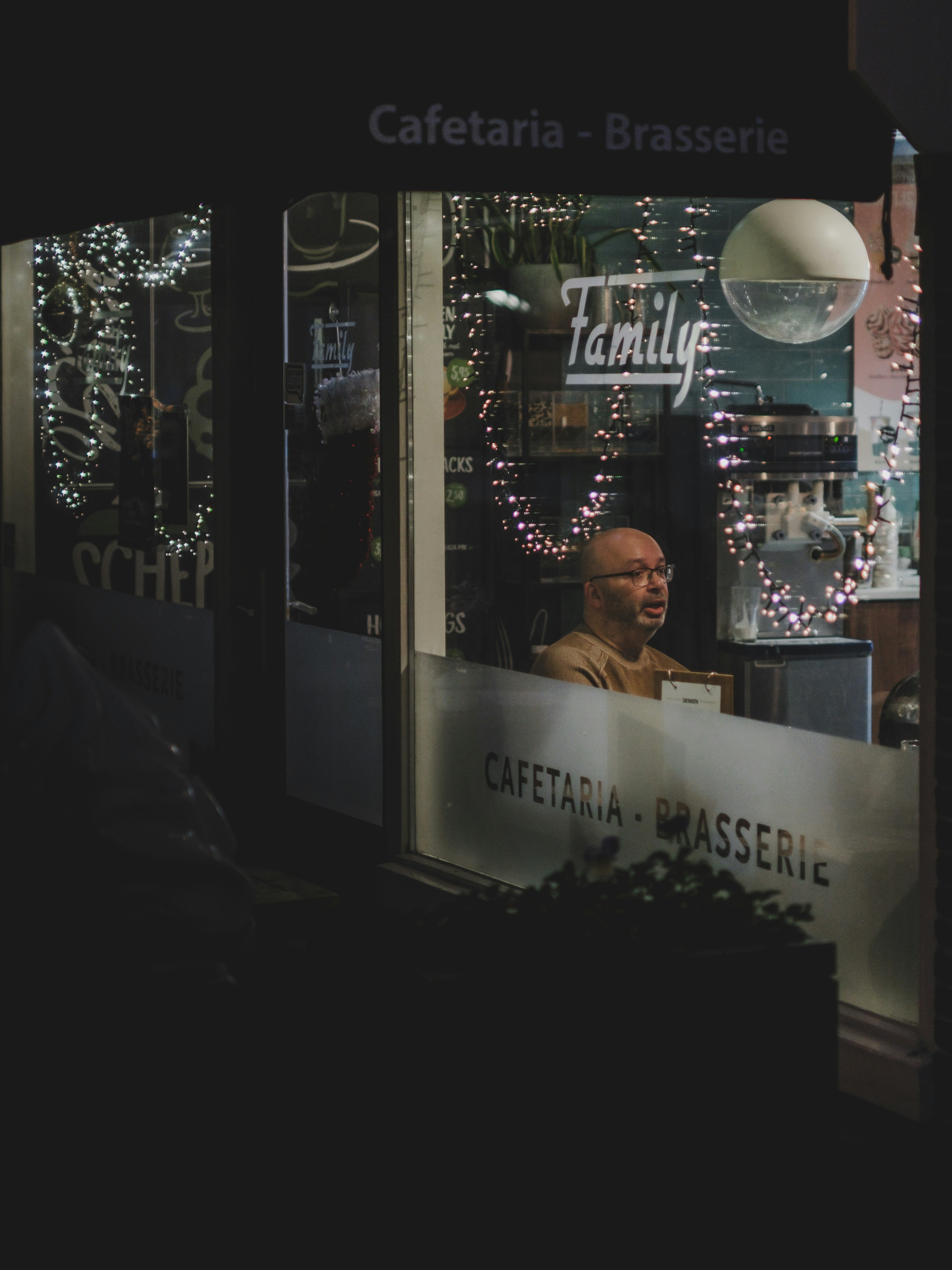 Quiet Café Portrait: A Barista's Gaze Through Neon Night