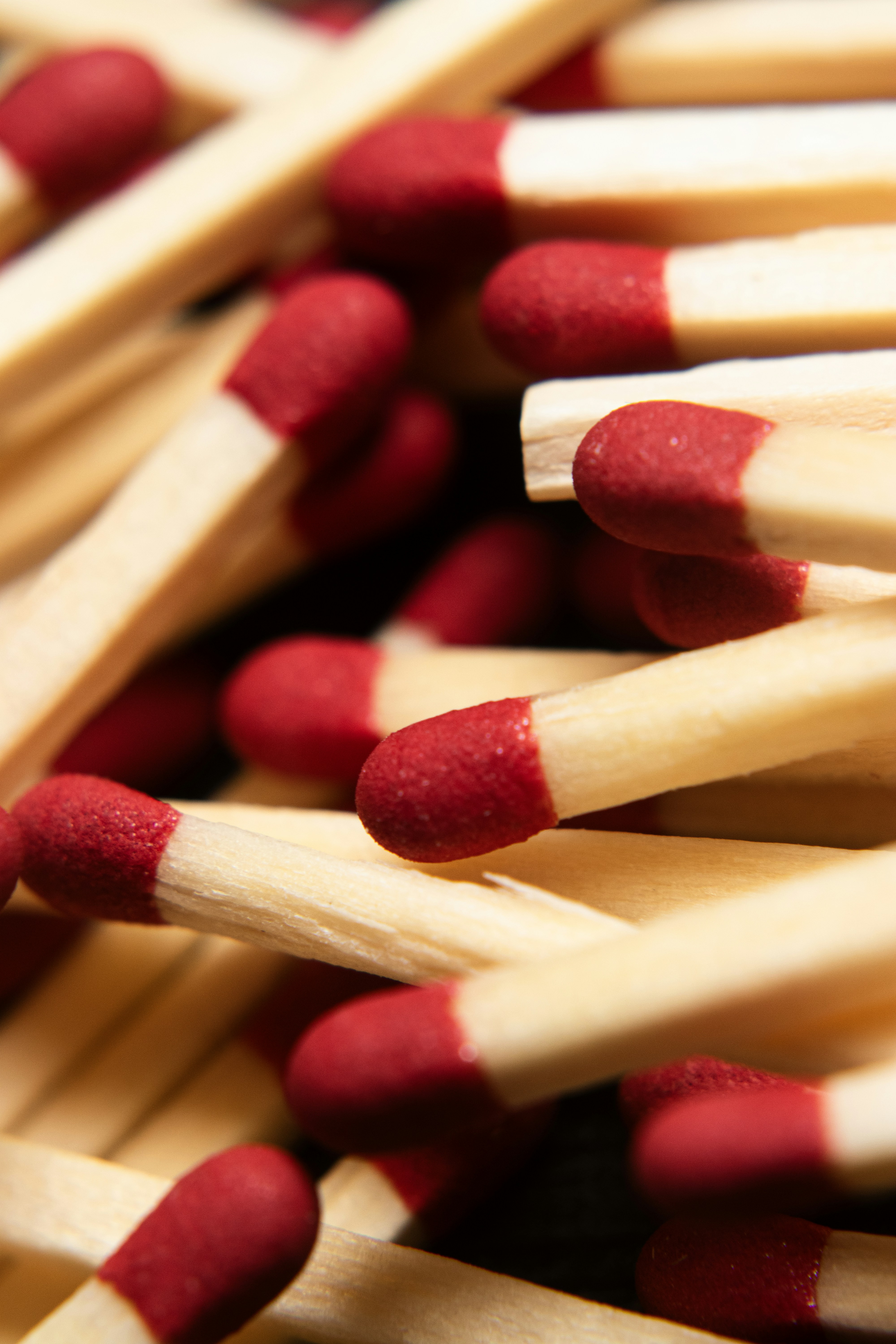 Crimson Tips: A Close-Up of Red-Knobbed Safety Matches in a Tangle