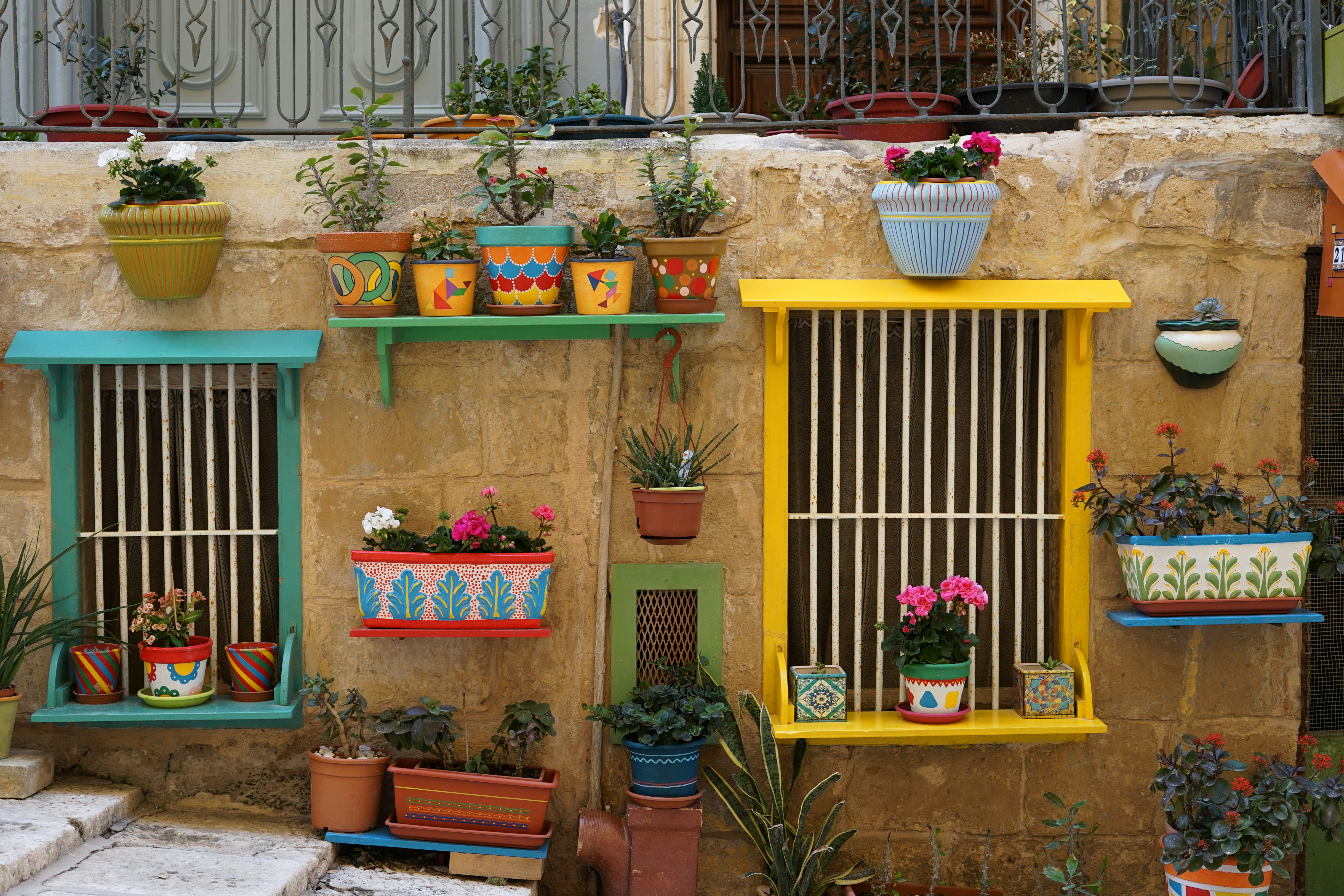 A Courtyard of Colorful Pots and Window Boxes