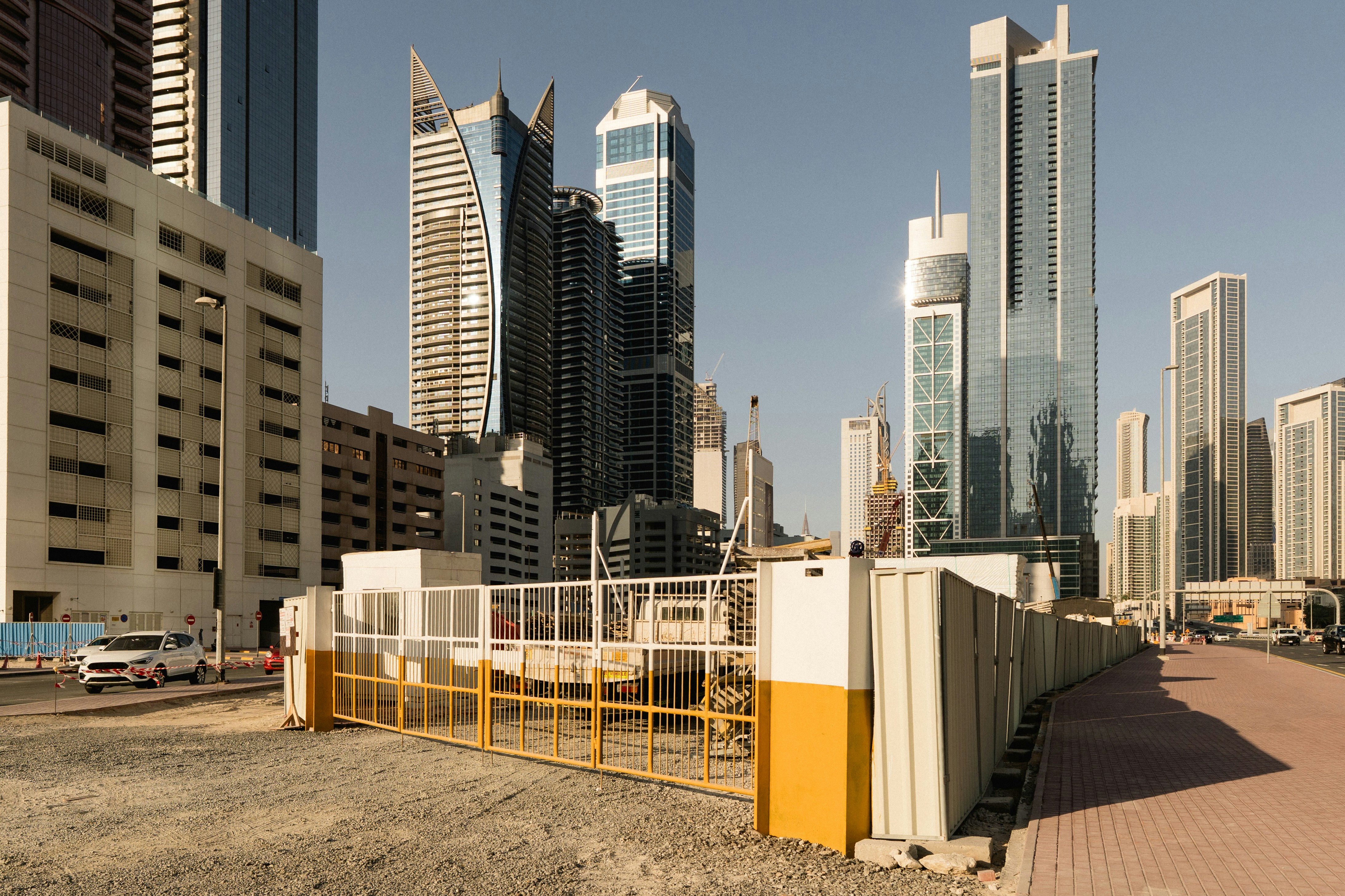 Urban Skyline Gate: A Barrier Between Deserted Lot and Towering Glass