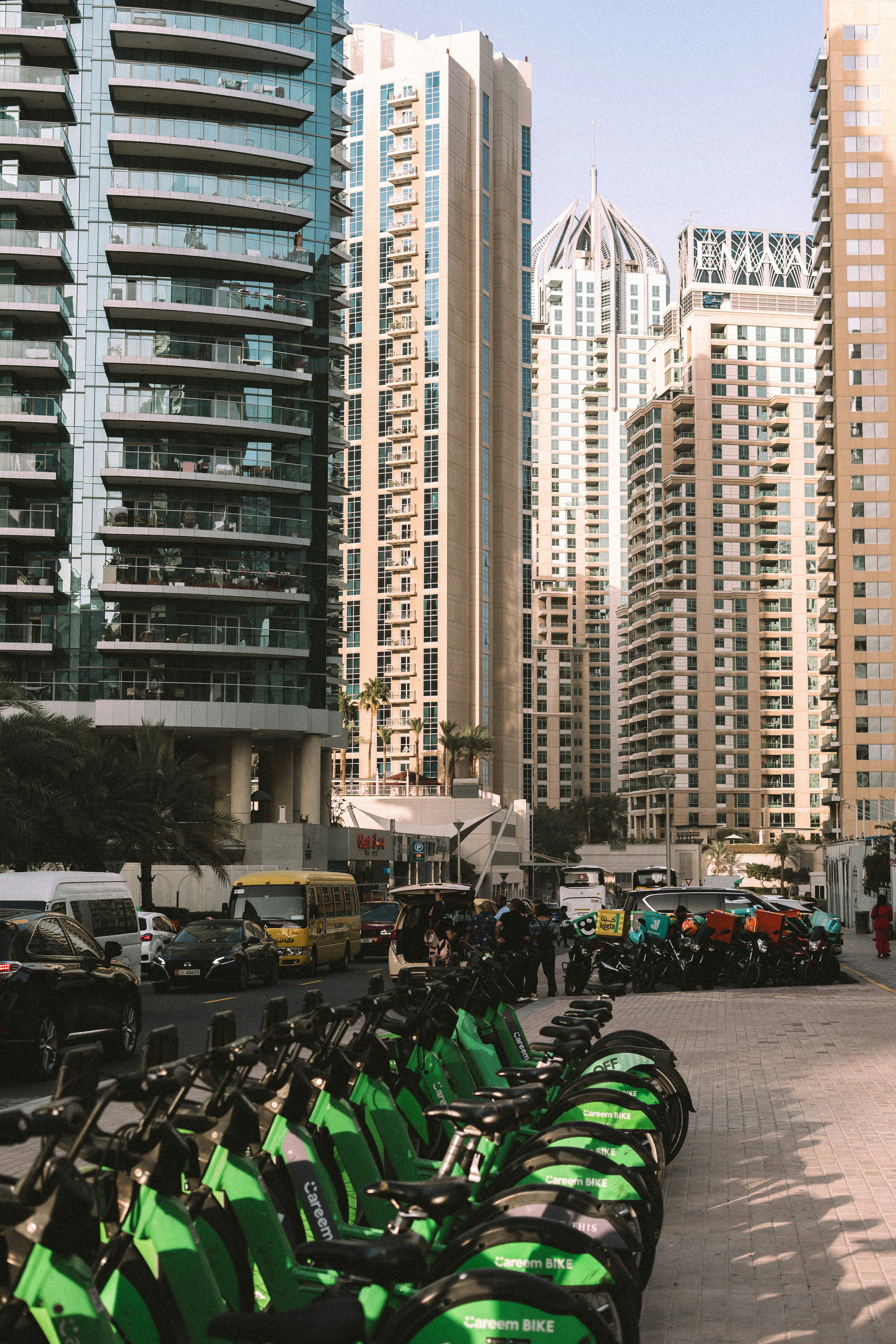 Row of Green Rental Bikes Nestled Along a Modern Dubai Street
