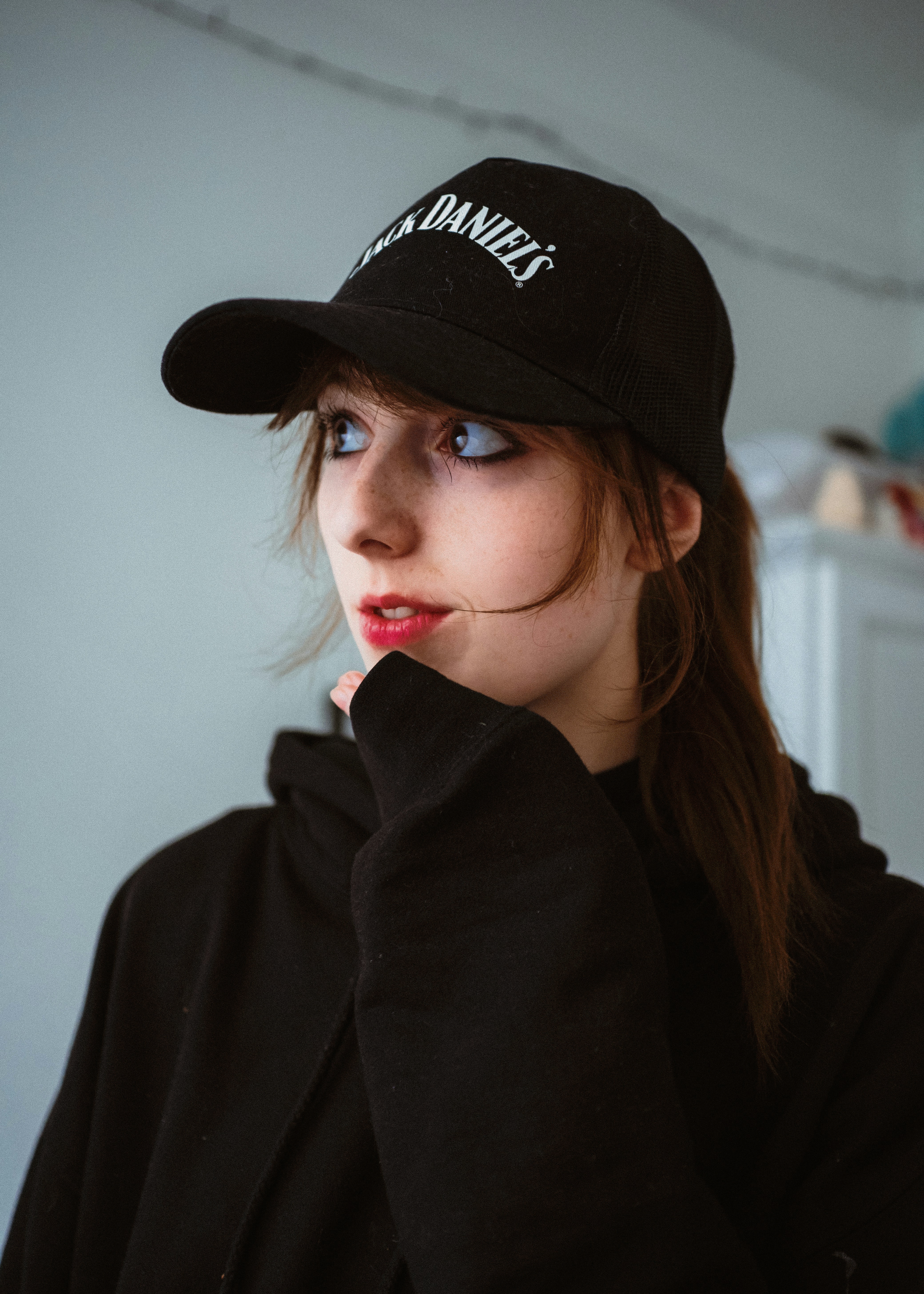 Cap and Contemplation: A Quiet Gaze in Hoodie Noir