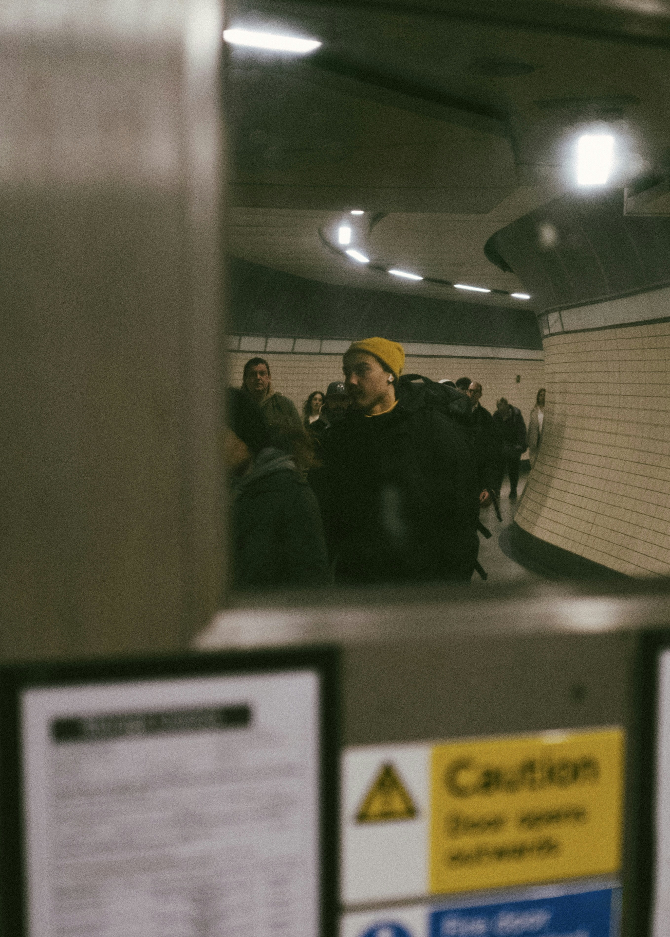 Yellow-beanie Moment in the Underground Crowd