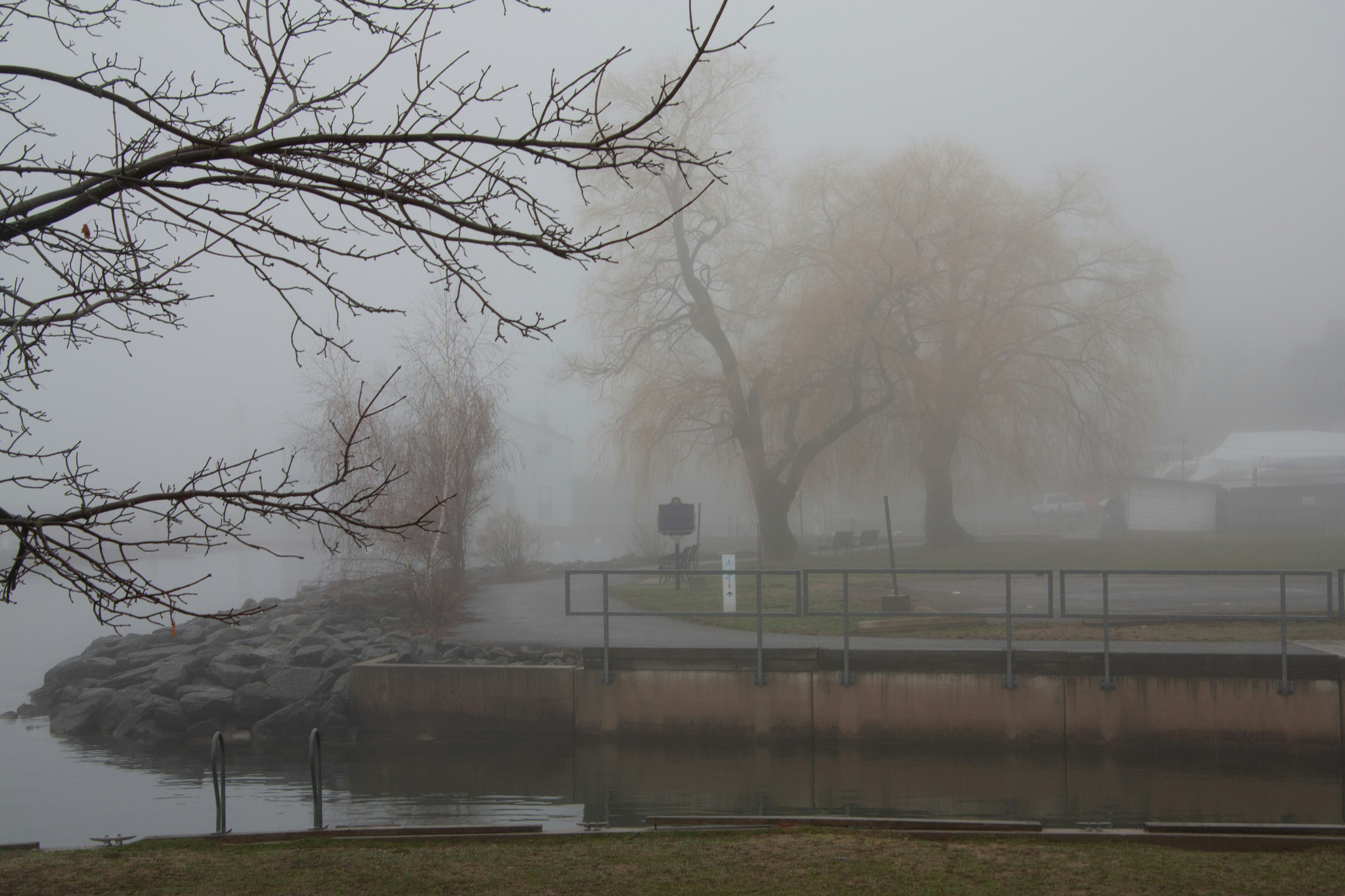 Mist on the Riverfront: A Quiet Dawn by the Fogbound Pier