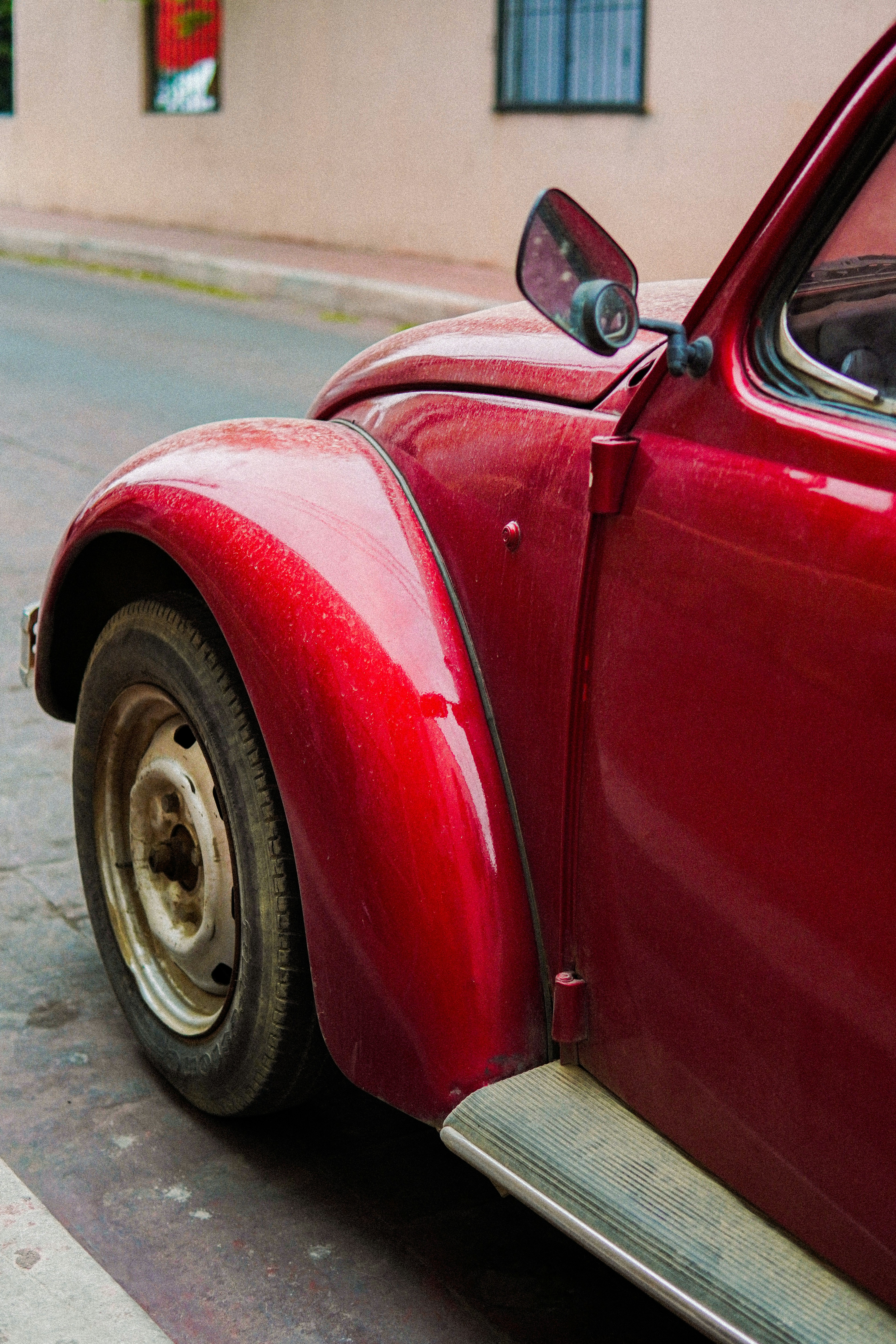 Red Vintage Vehicle: A Close-Cropped Echo of Curves and Chrome