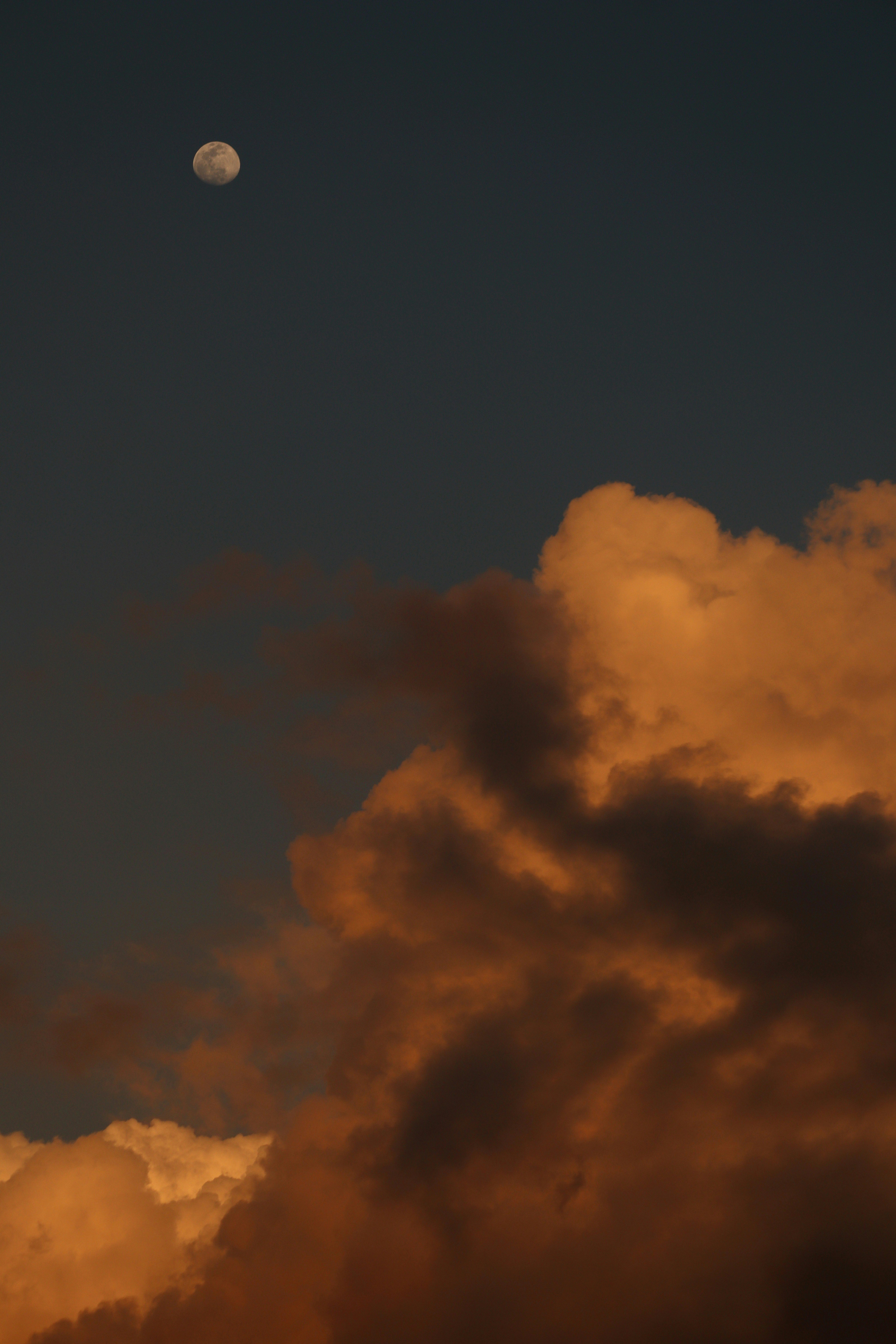 Moonlit Peak: Cloudscape on a Dusk Horizon