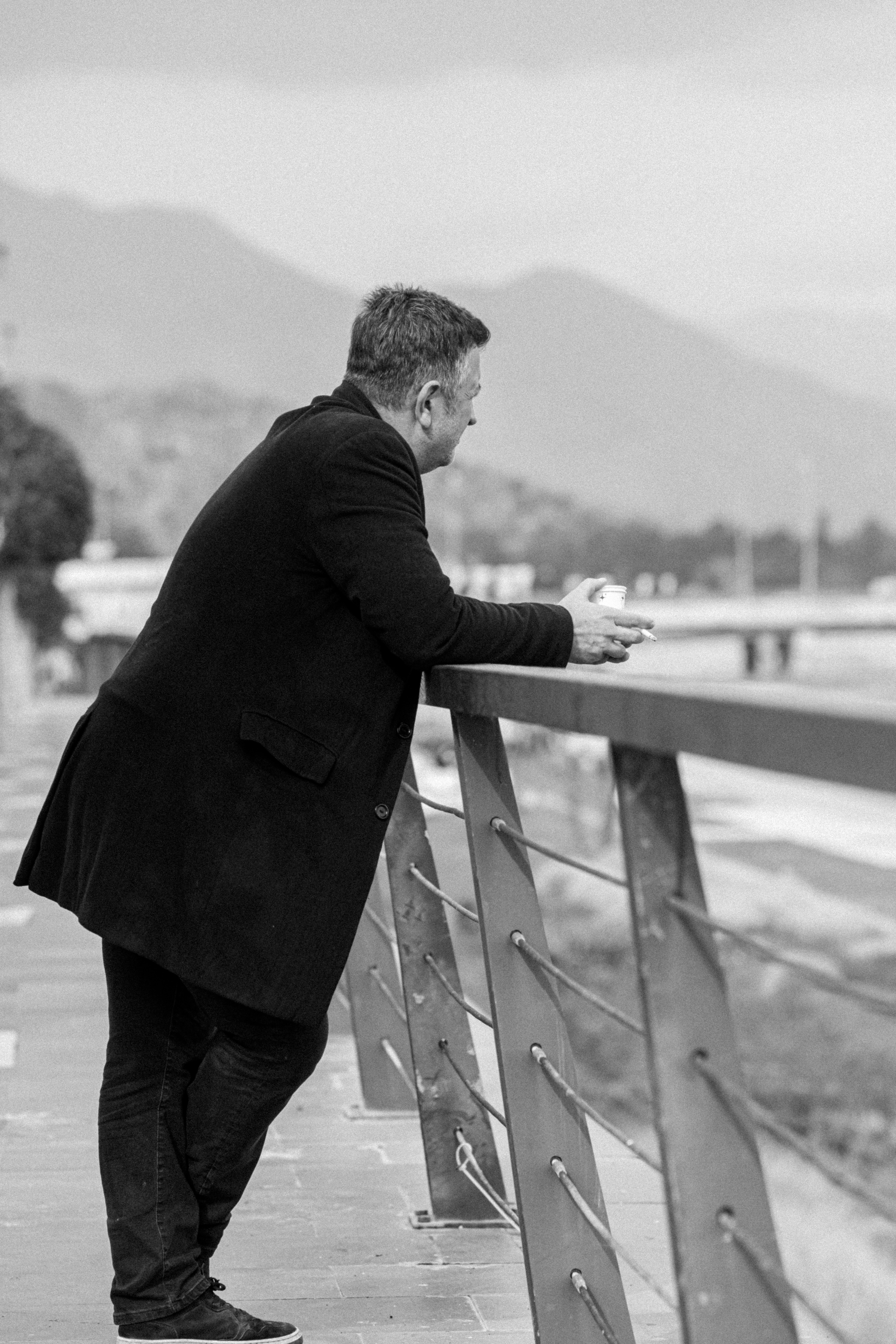 Mid-Stride Contemplation on the Riverside Rail