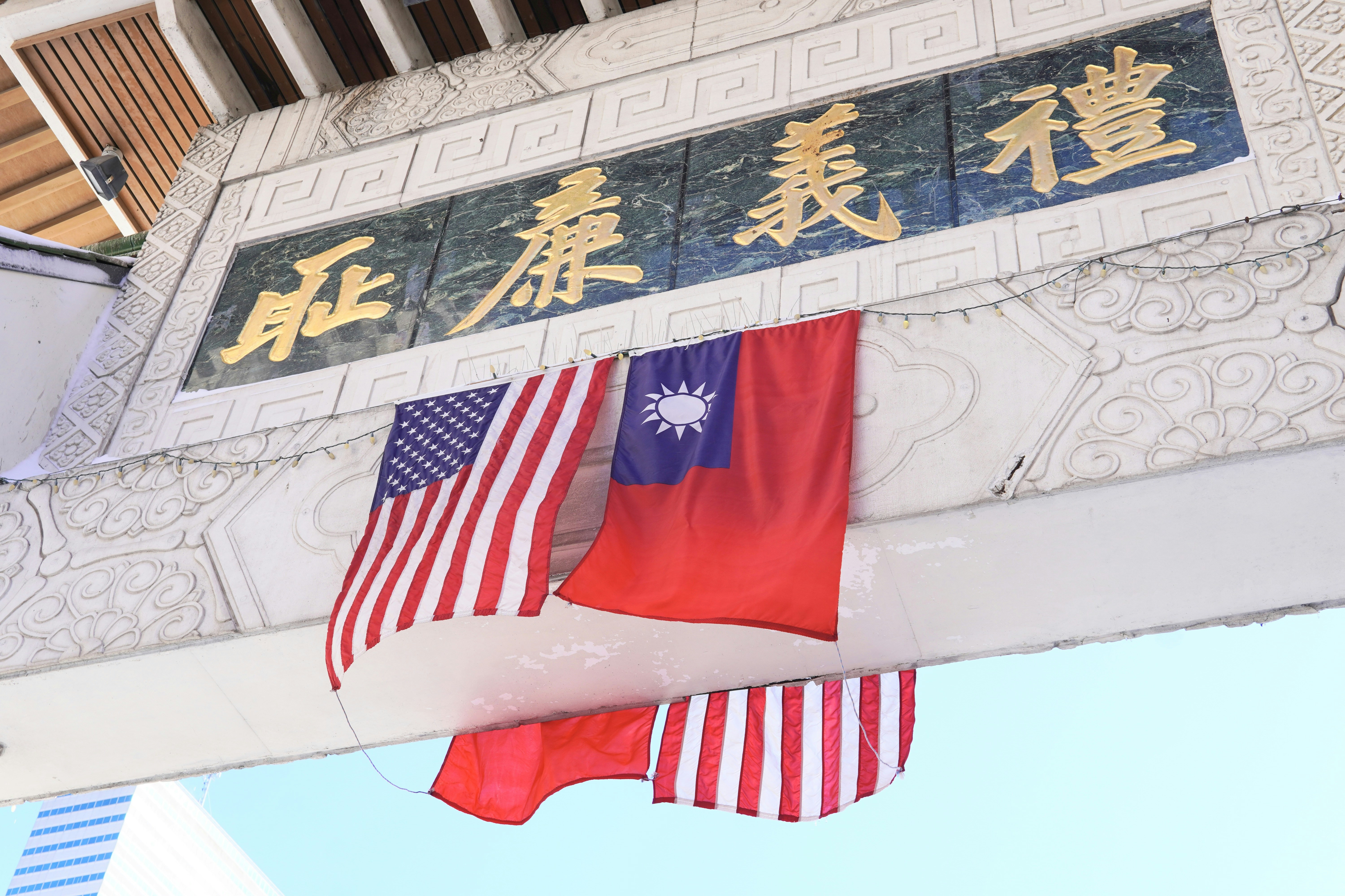 Lanterned Gateway: Flags at a Temple Arch