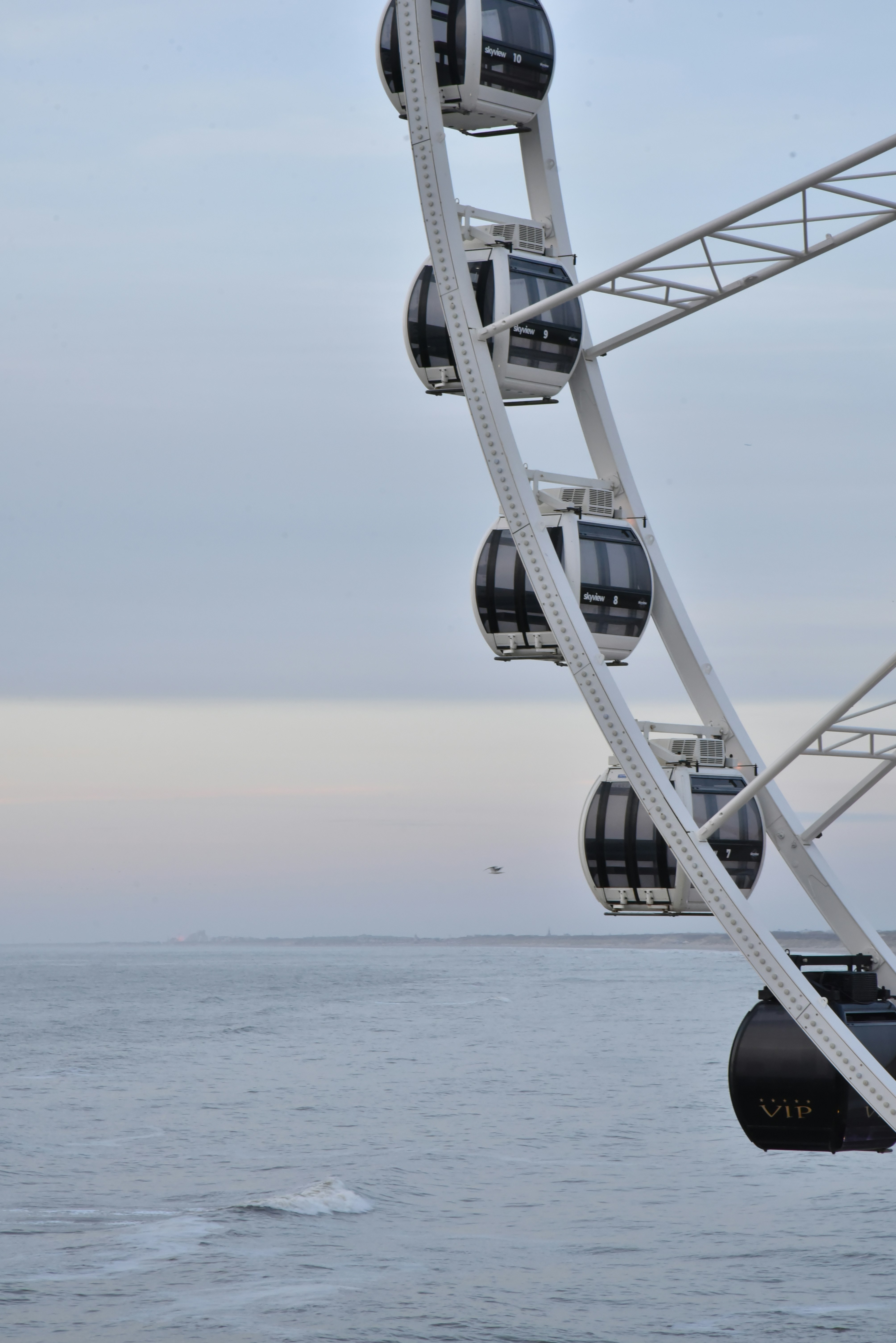 Moonlit Wheel: A Seaside Ferris Wheel Stretches Along the Horizon