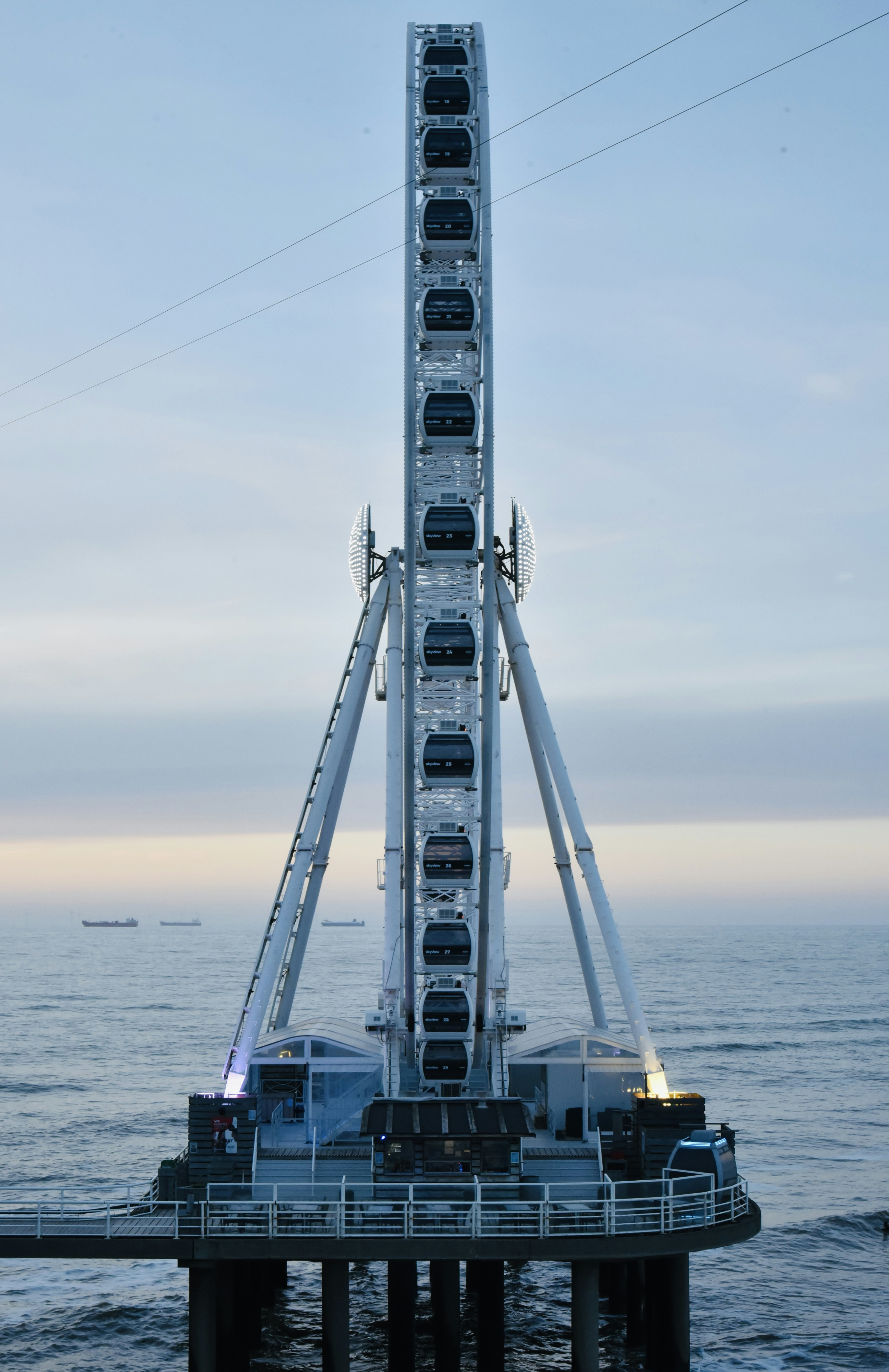 The Pier’s Silent Giant: A Ferris Wheel Breathing Over the Sea