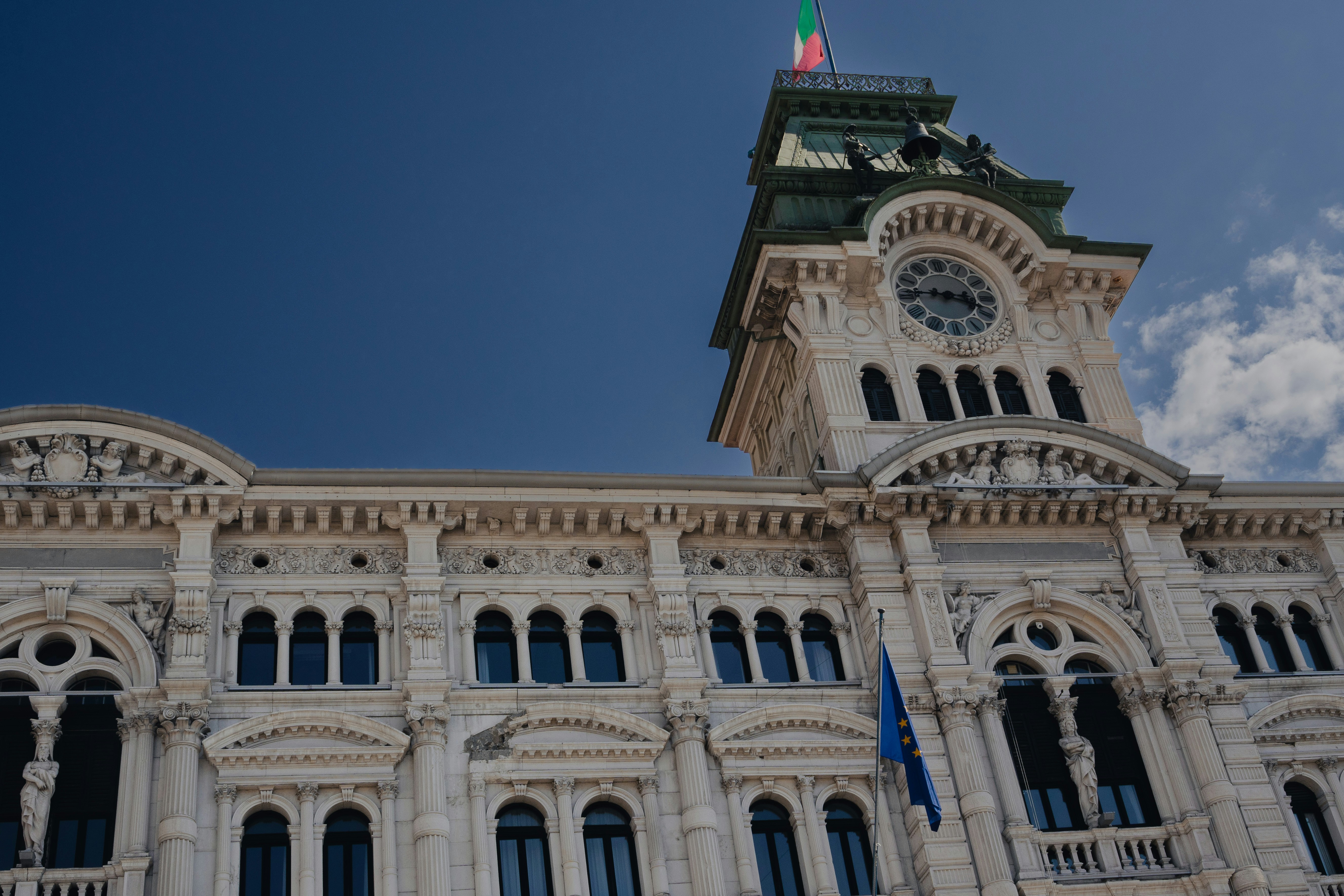 Clocktower Facade: Cathedral-Style Building Reaching Toward a Clear Blue Sky