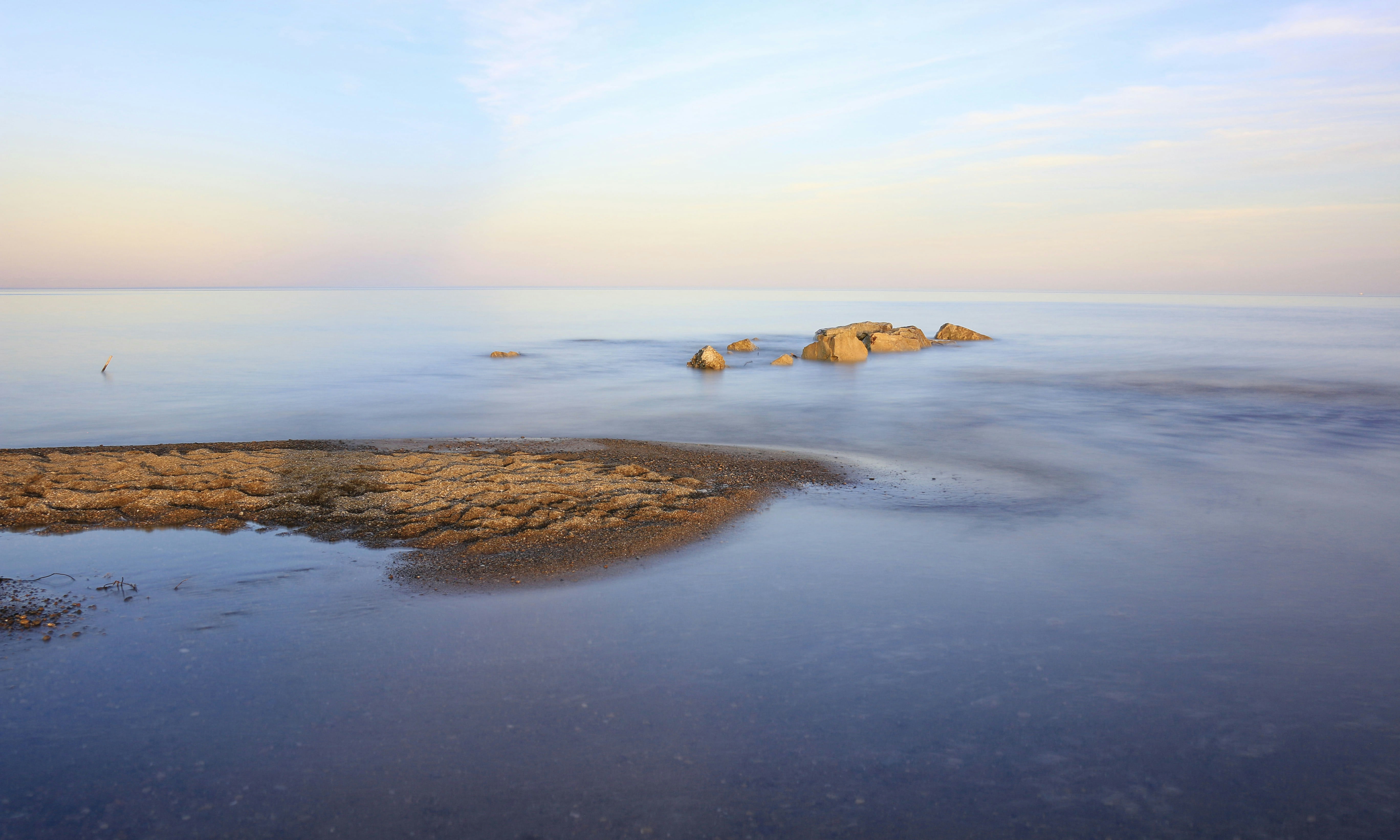 Low Tide Reverie: Gentle Rocks and Quiet Waters at Dusk