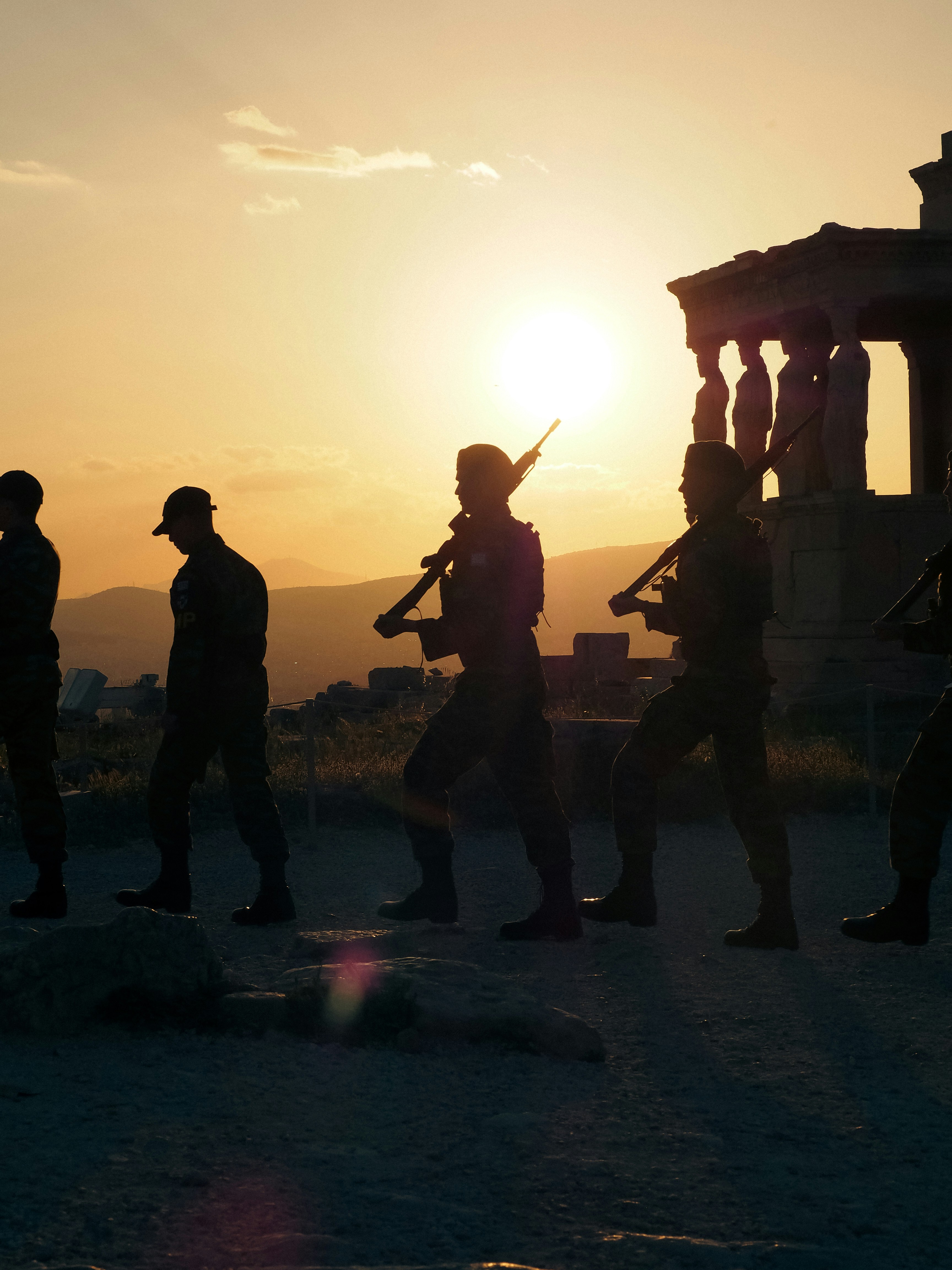 Sunlit Silence: Silhouettes of Soldiers at Dusk