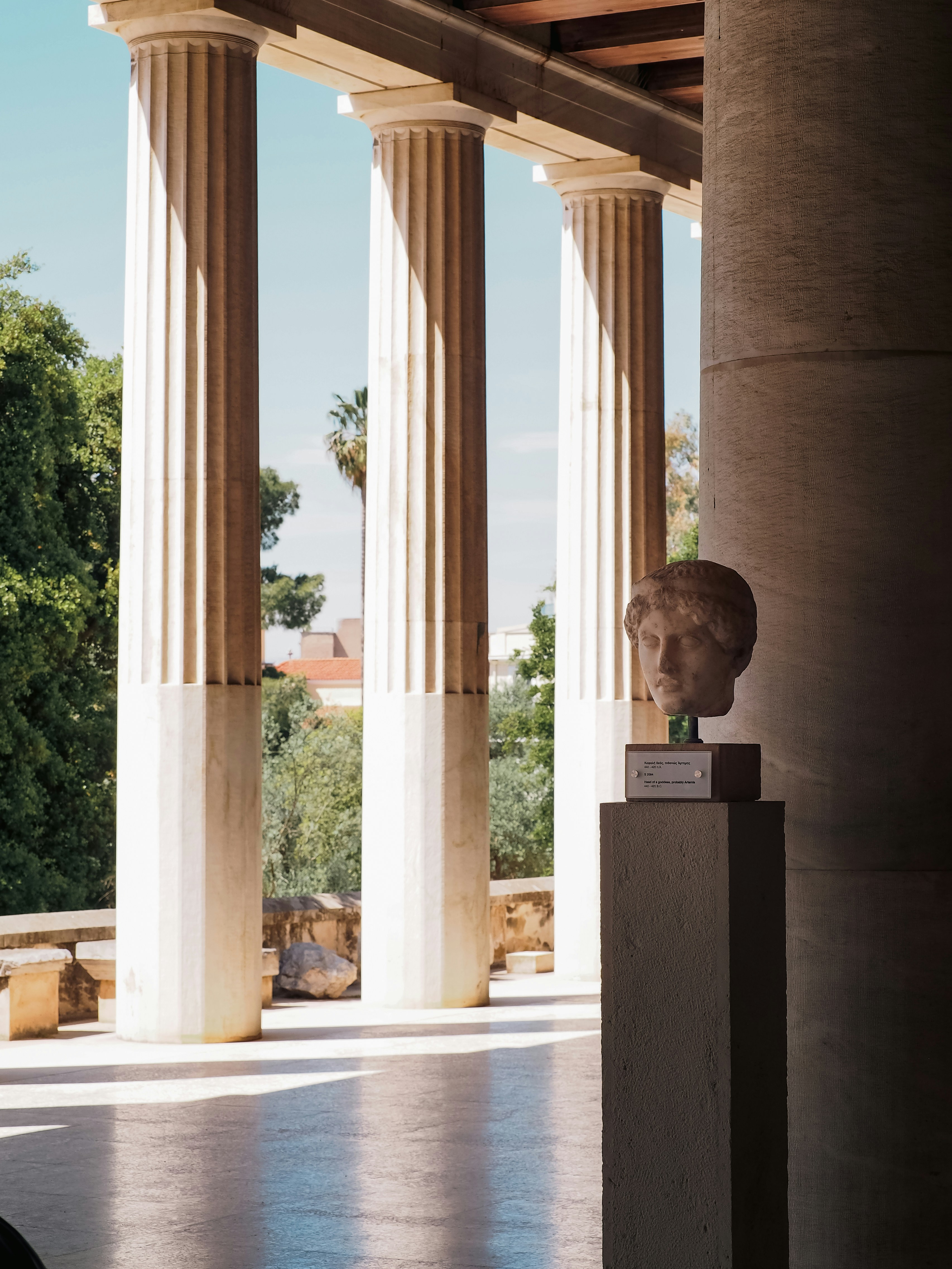 Stone Portraits: A Classical Corridor and a Head on Stand