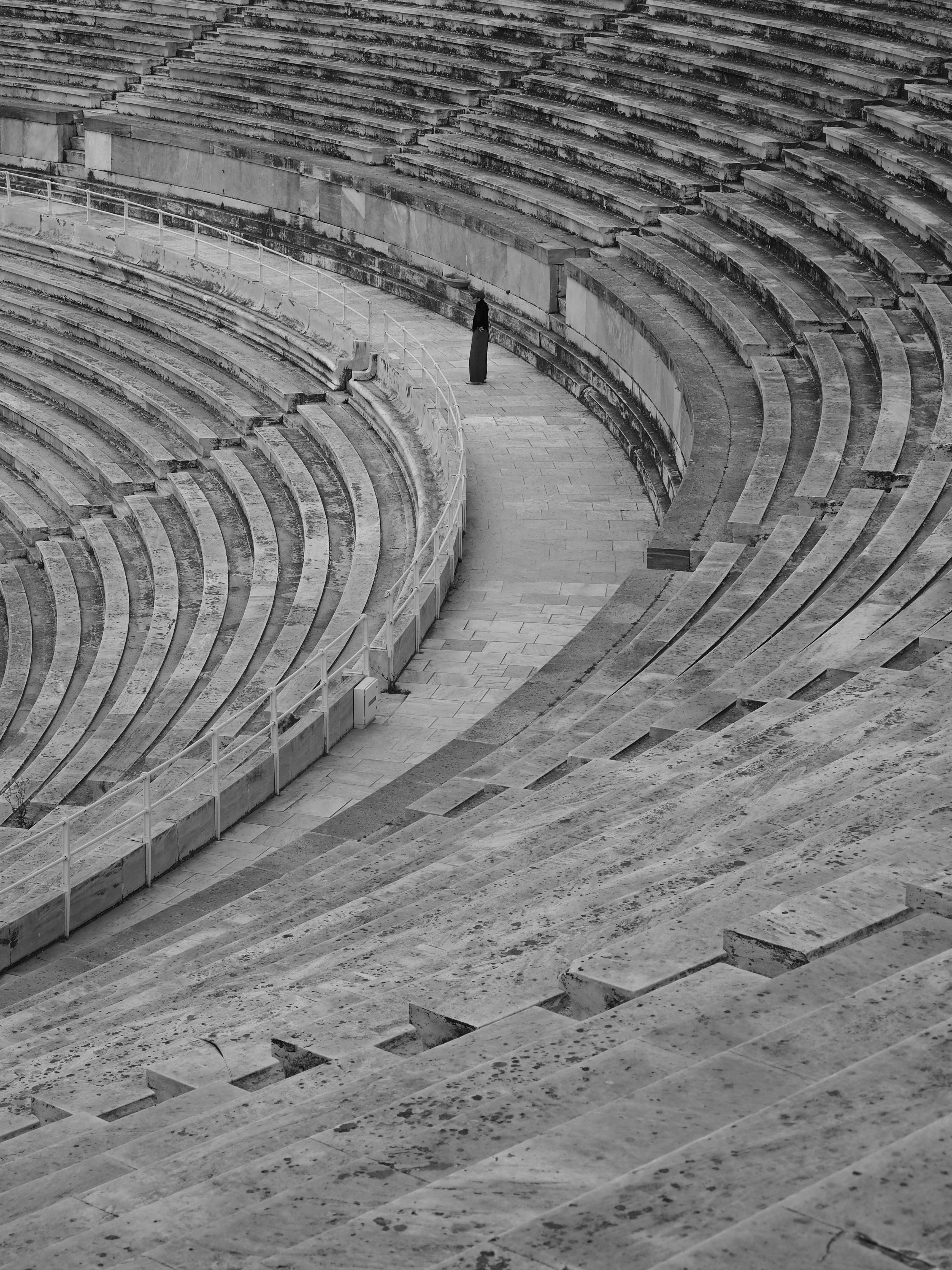  solitary figure in a concrete amphitheater