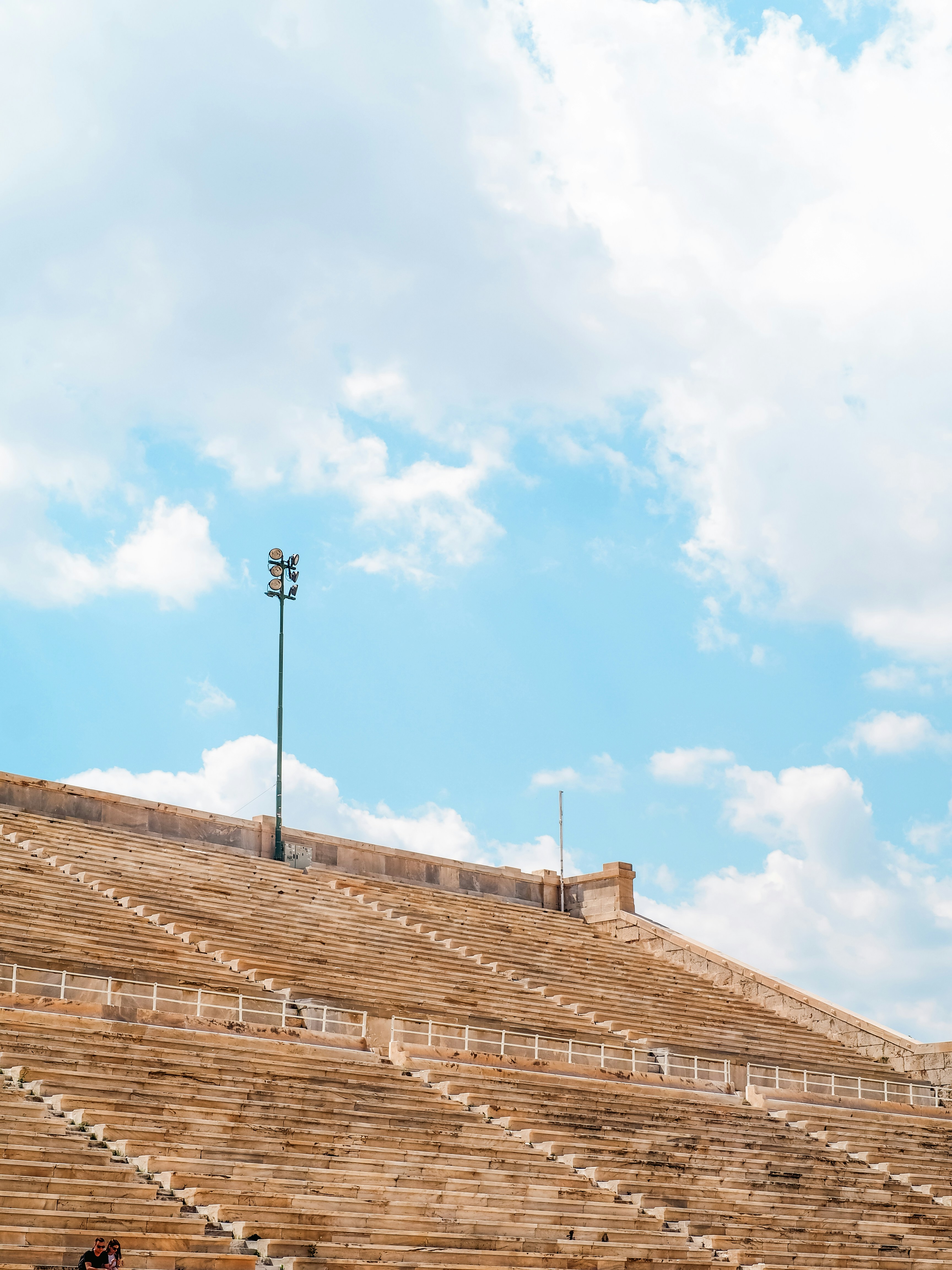 Seat Rows Under a Bright Sky: A Quiet Stadium Vista