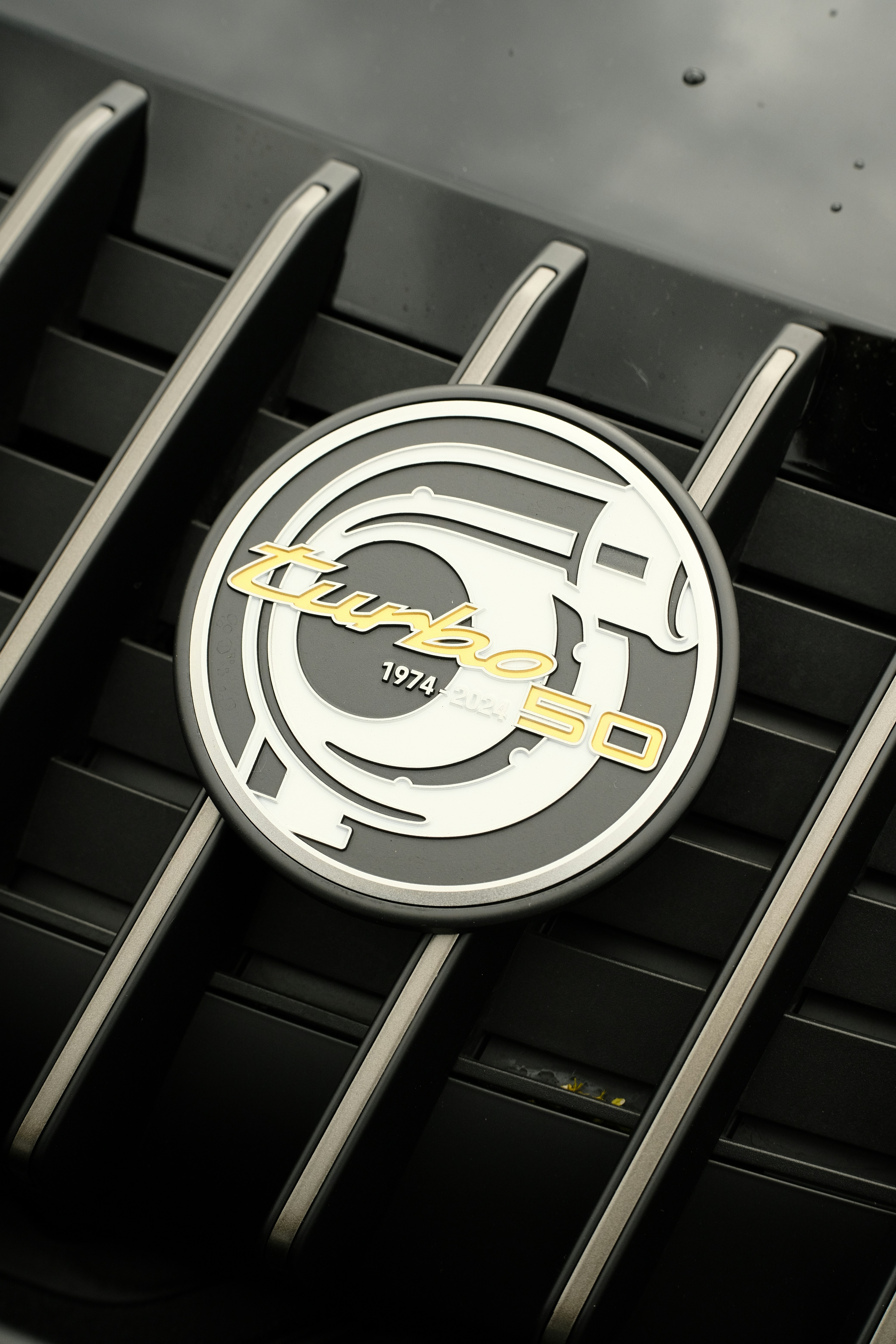 Emblem in Focus: A Close-Up of Ford Mustang Branding on Grille