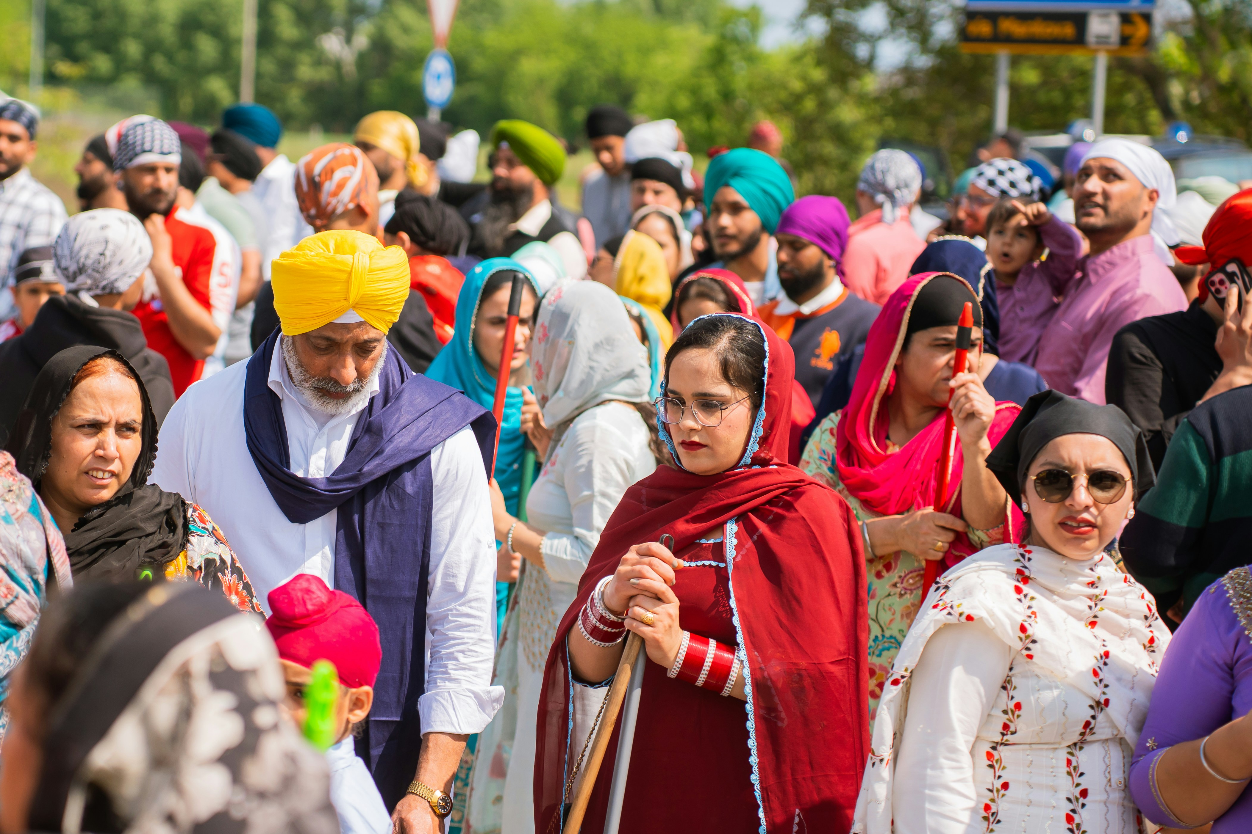 Colorful Crowd in a Sikh Parade: Threads of Tradition Amid Street Festivity