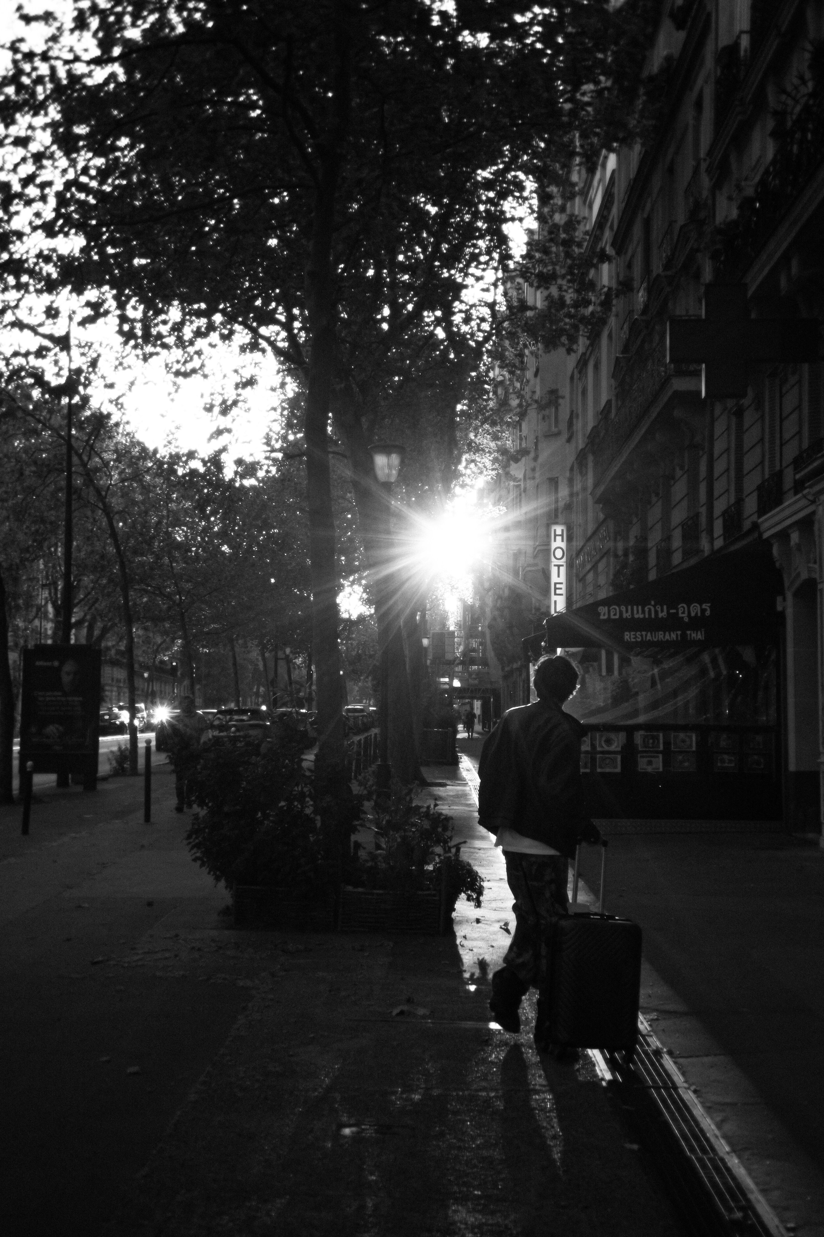 Midtown Stroll: A Traveler Steps Toward a Distant Luminosity