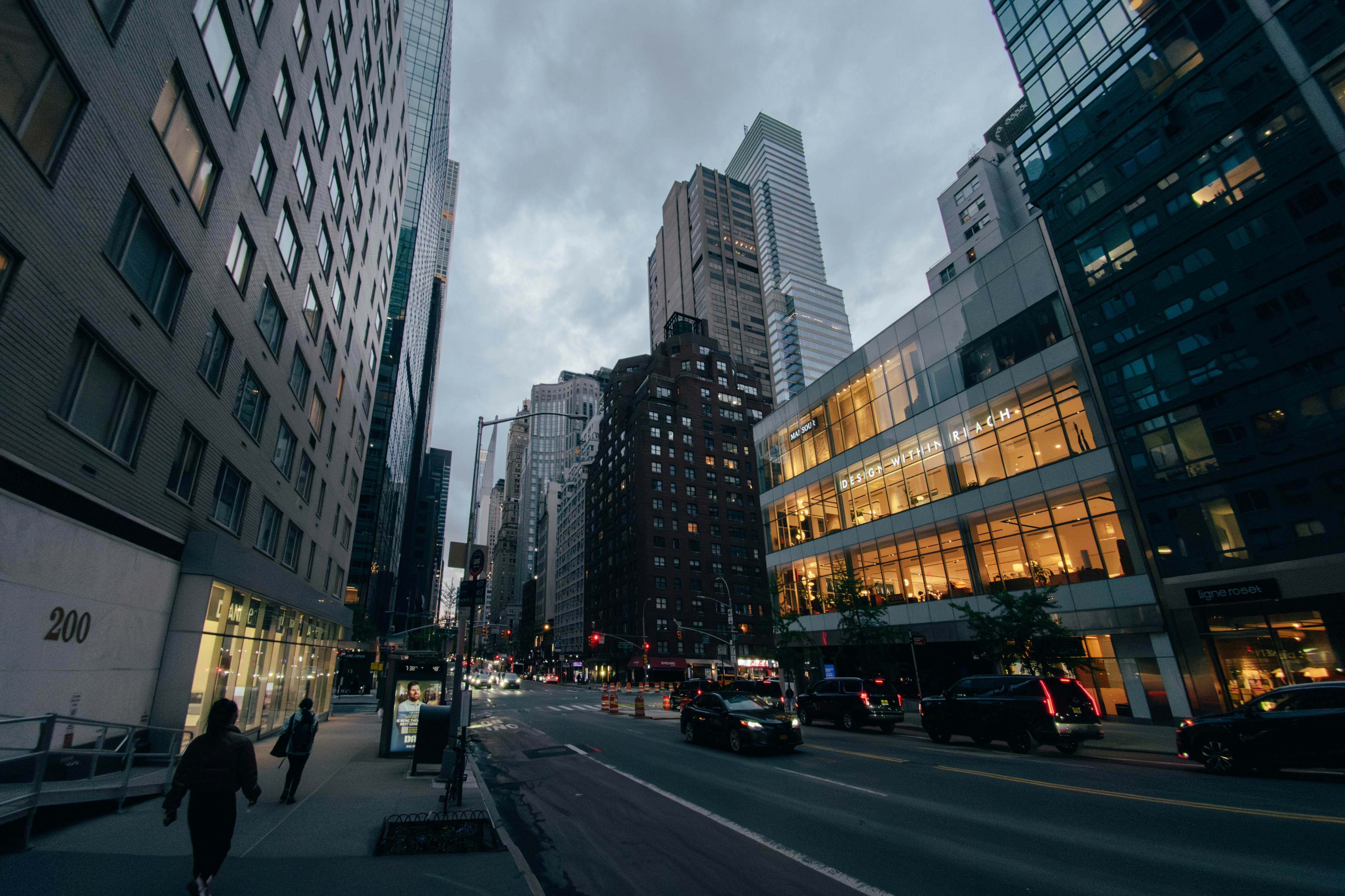 Midtown Cascade: Cars and Glass Canopy in Evening City Sweep