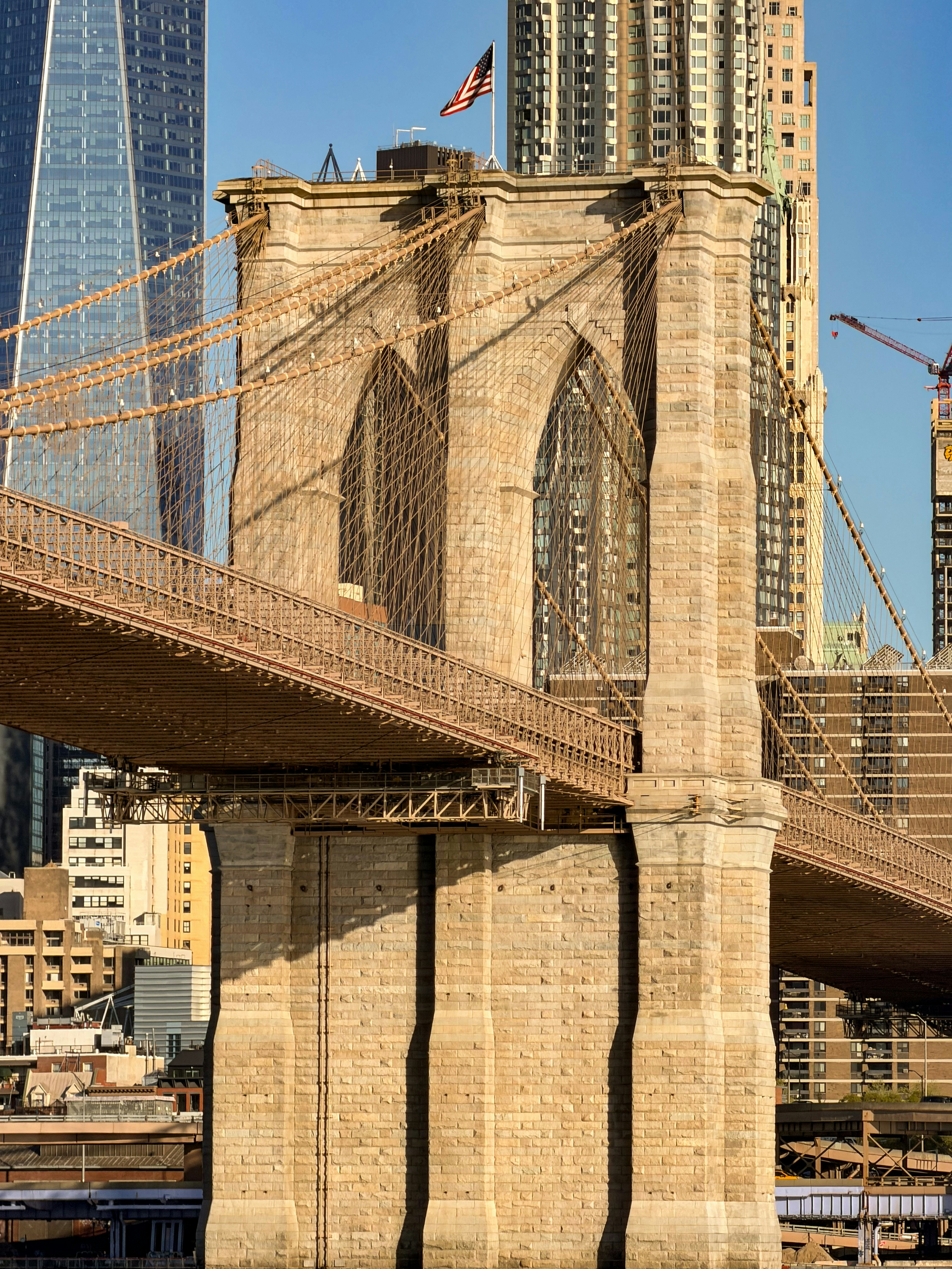 Bridge Looms Over a Cityscape: Towers Framing the Stone Arches