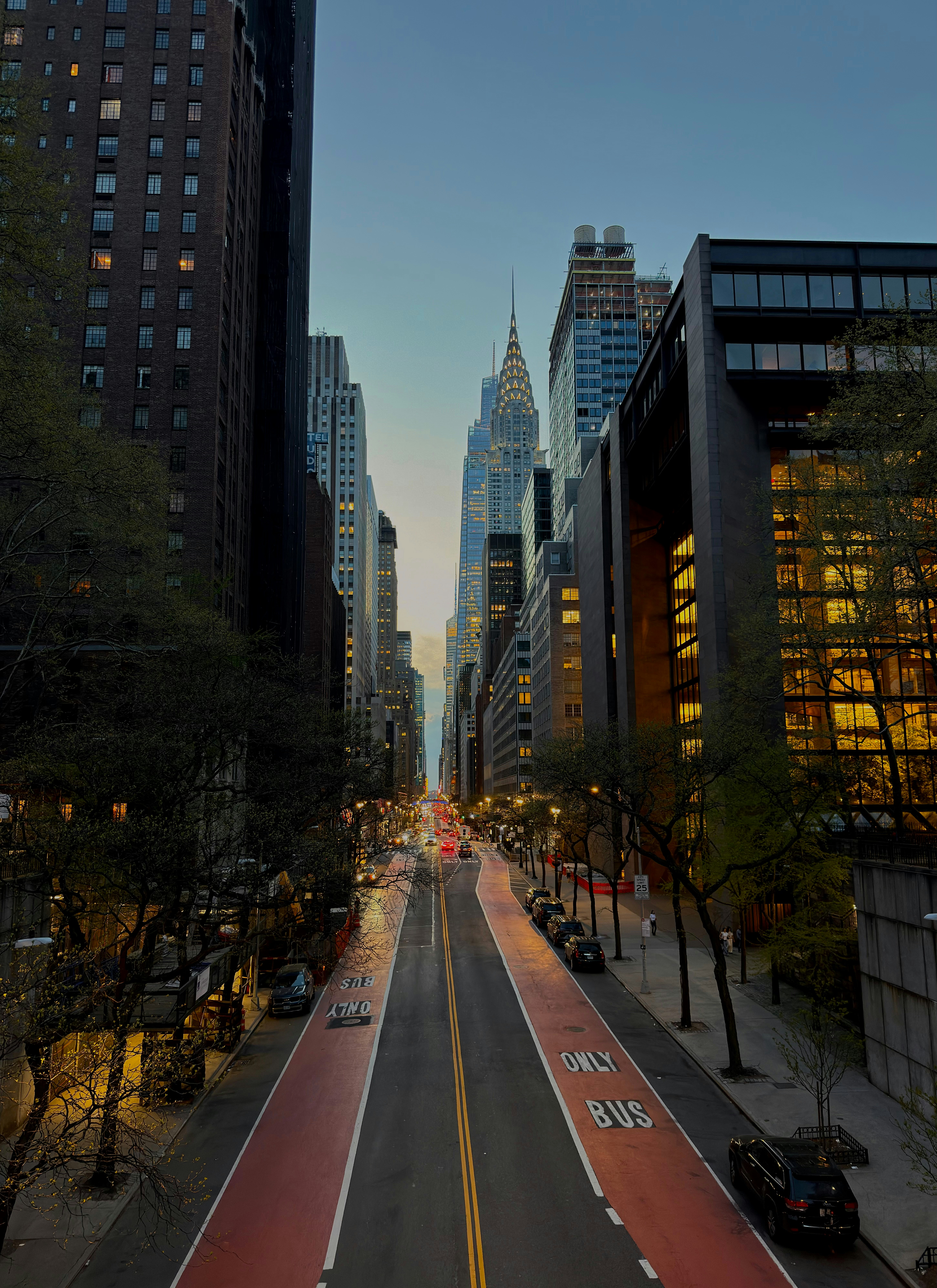 Dawn in the Canyon: A City Street Separated by Tall Glass and Red Lanes