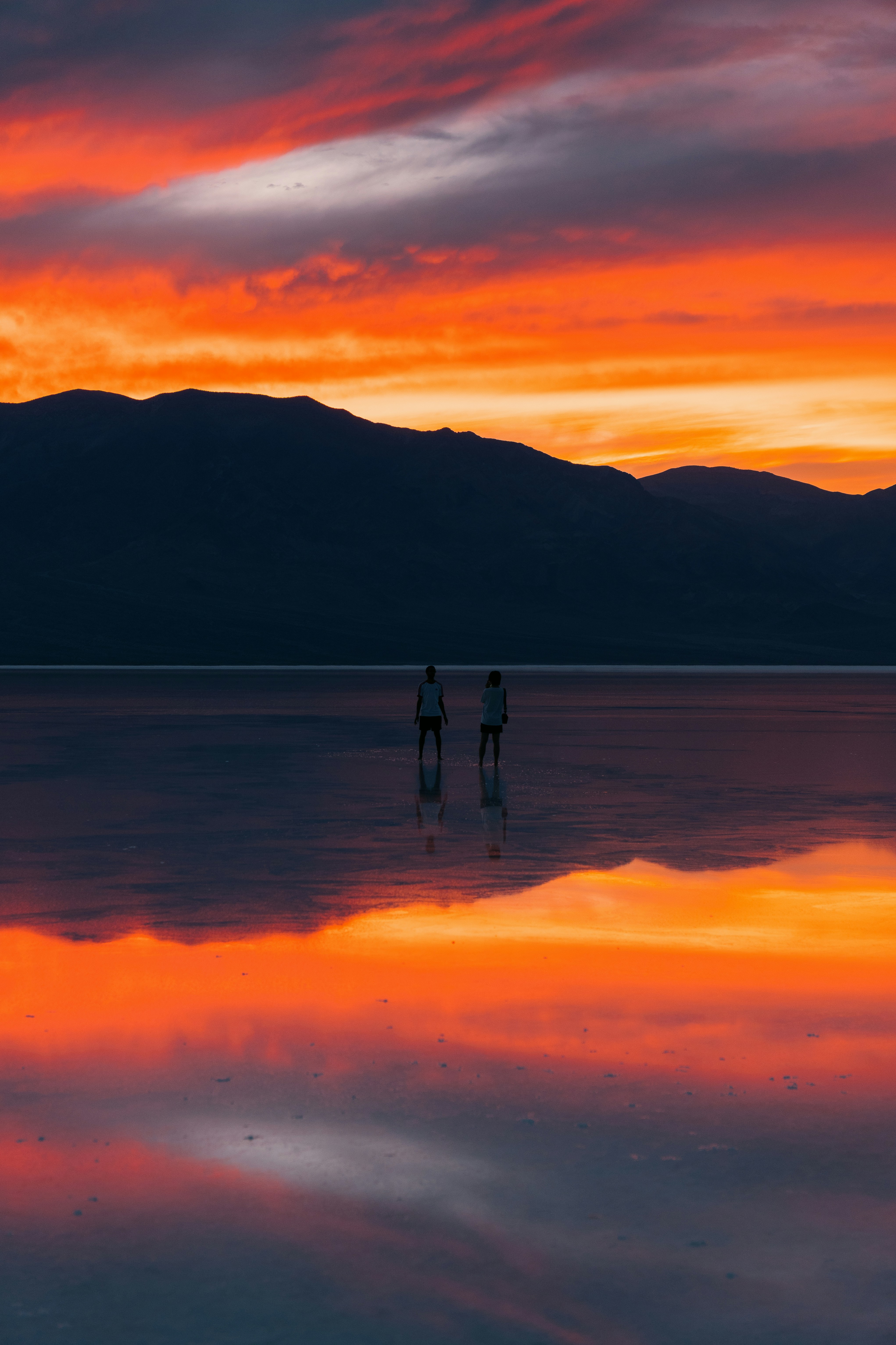 Two Silhouettes, a Fiery Horizon, and a Silent Salt Flat