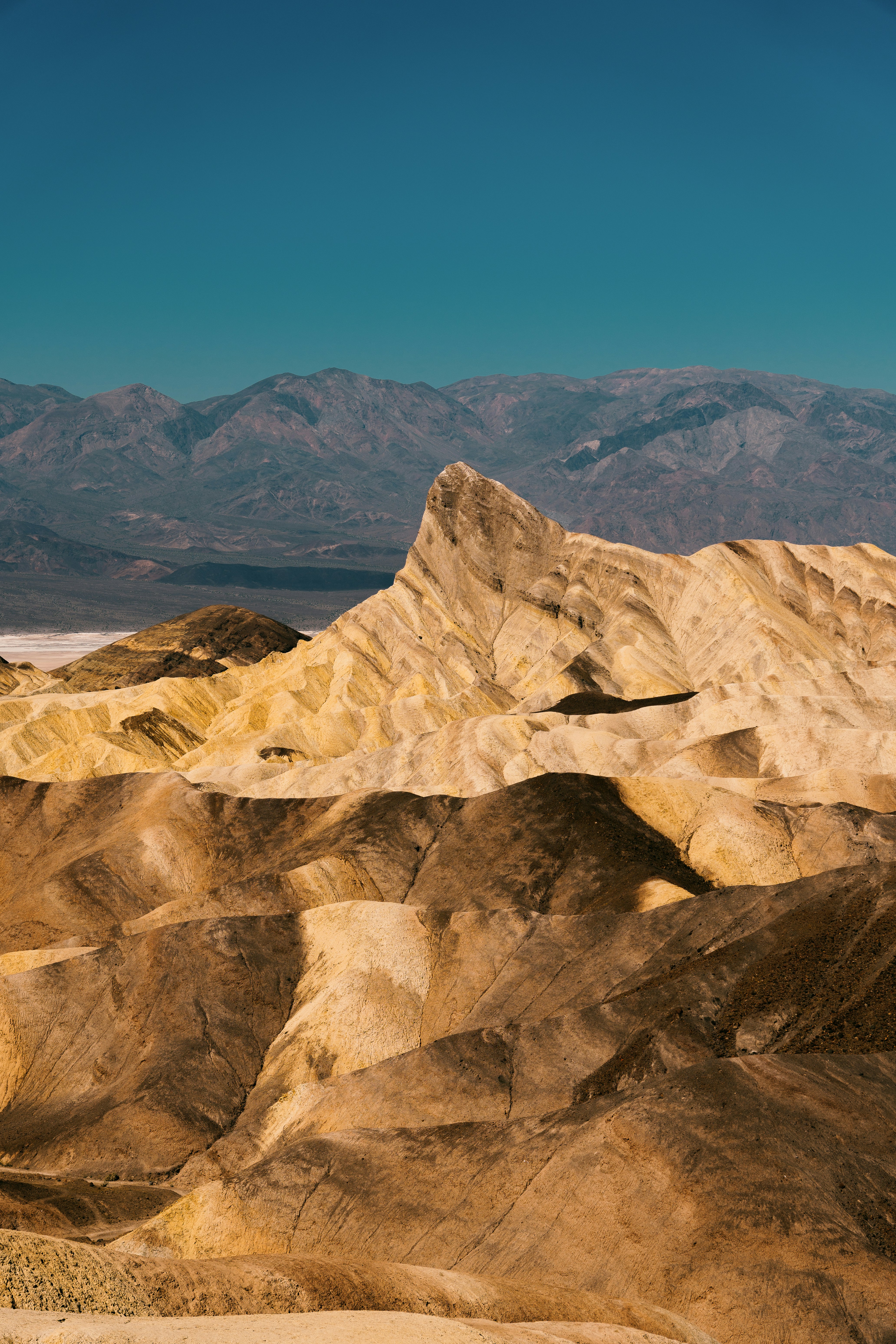 Desert Carved Peaks Under A Clear Desert Sky
