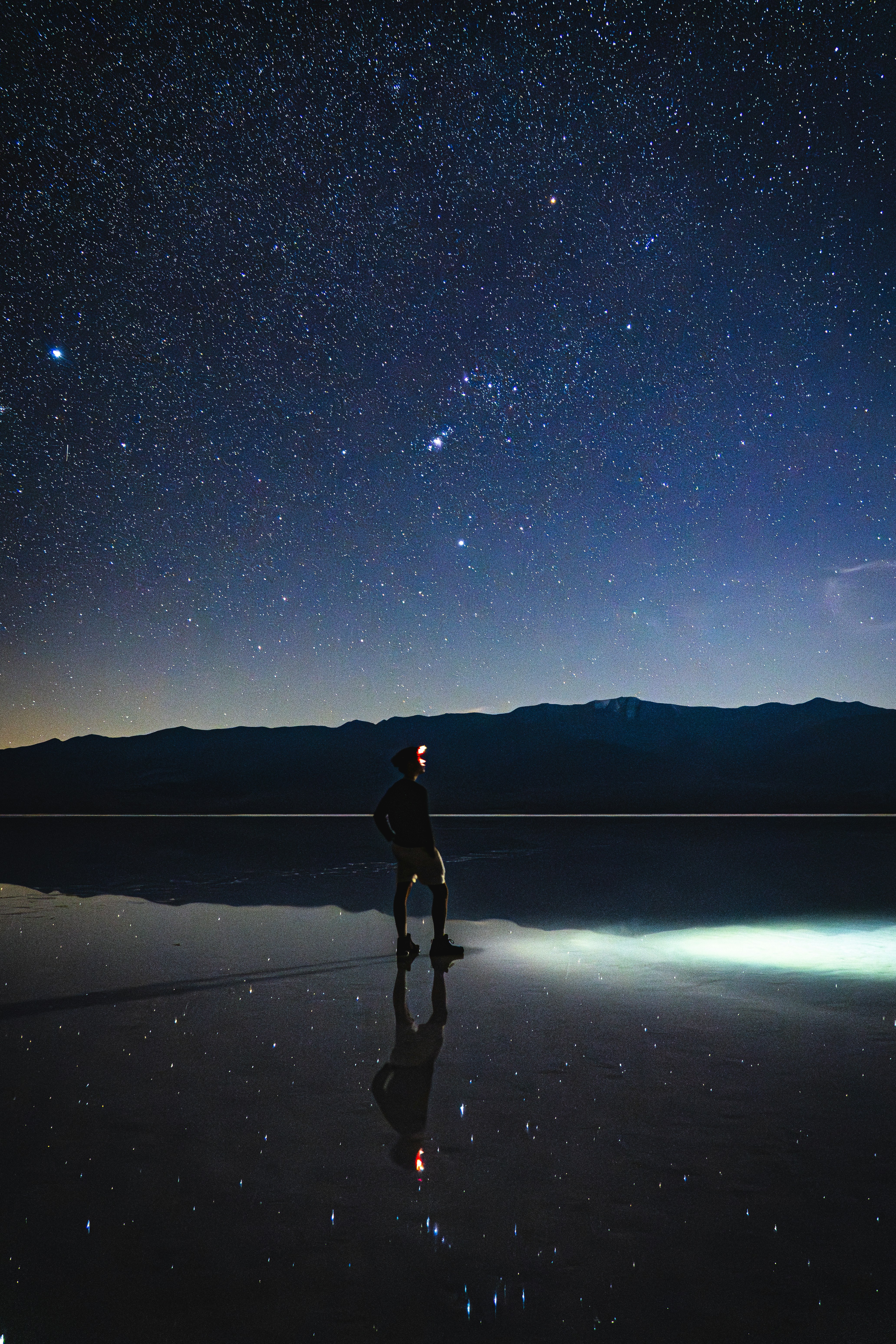 Night Wanderer Over a Glassy Lake Under a Star-Wet Sky