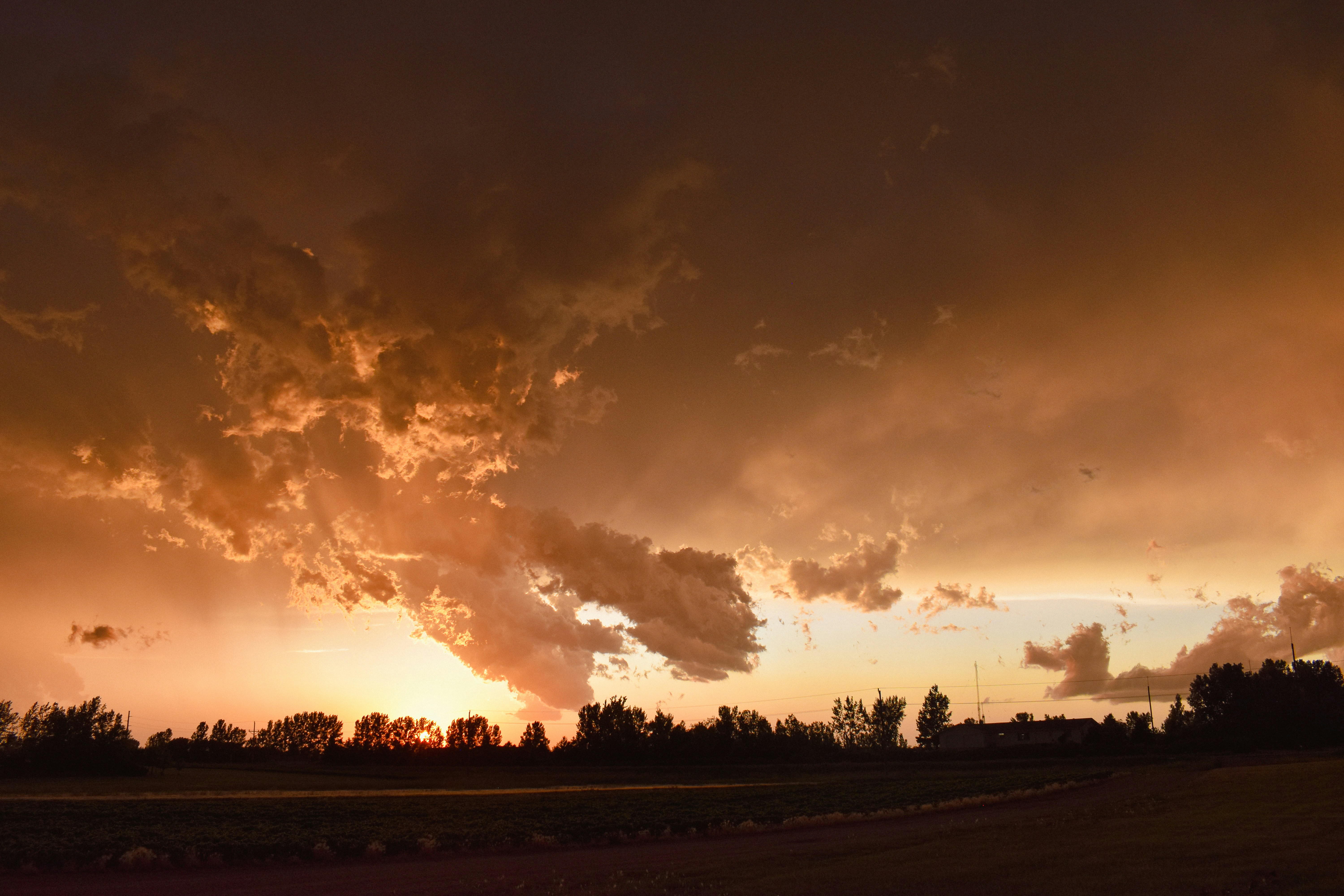 Dusk Sky on the Horizon: Ember Clouds Over Quiet Farmland