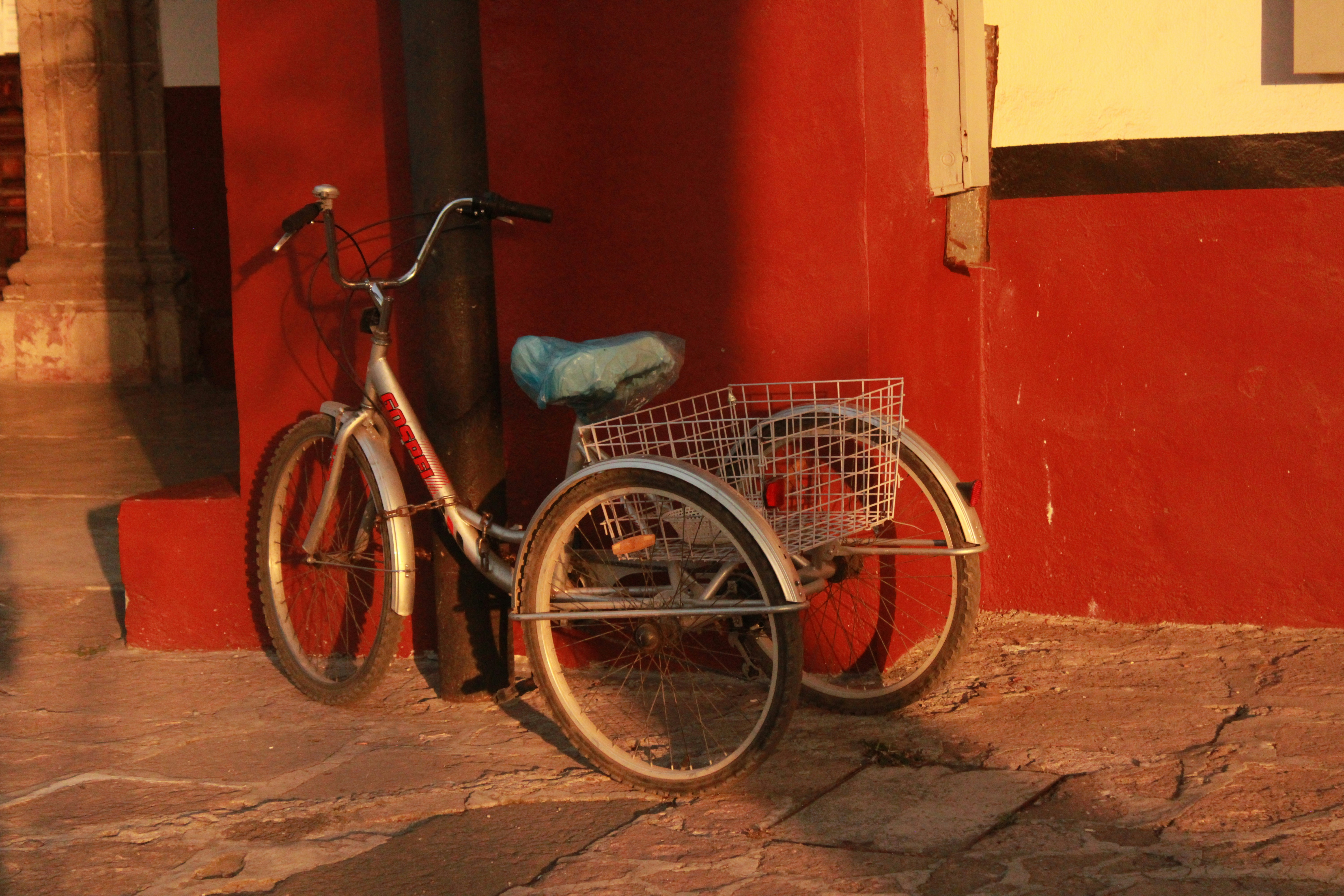 Red Bicycle Repose by a Sunlit Wall
