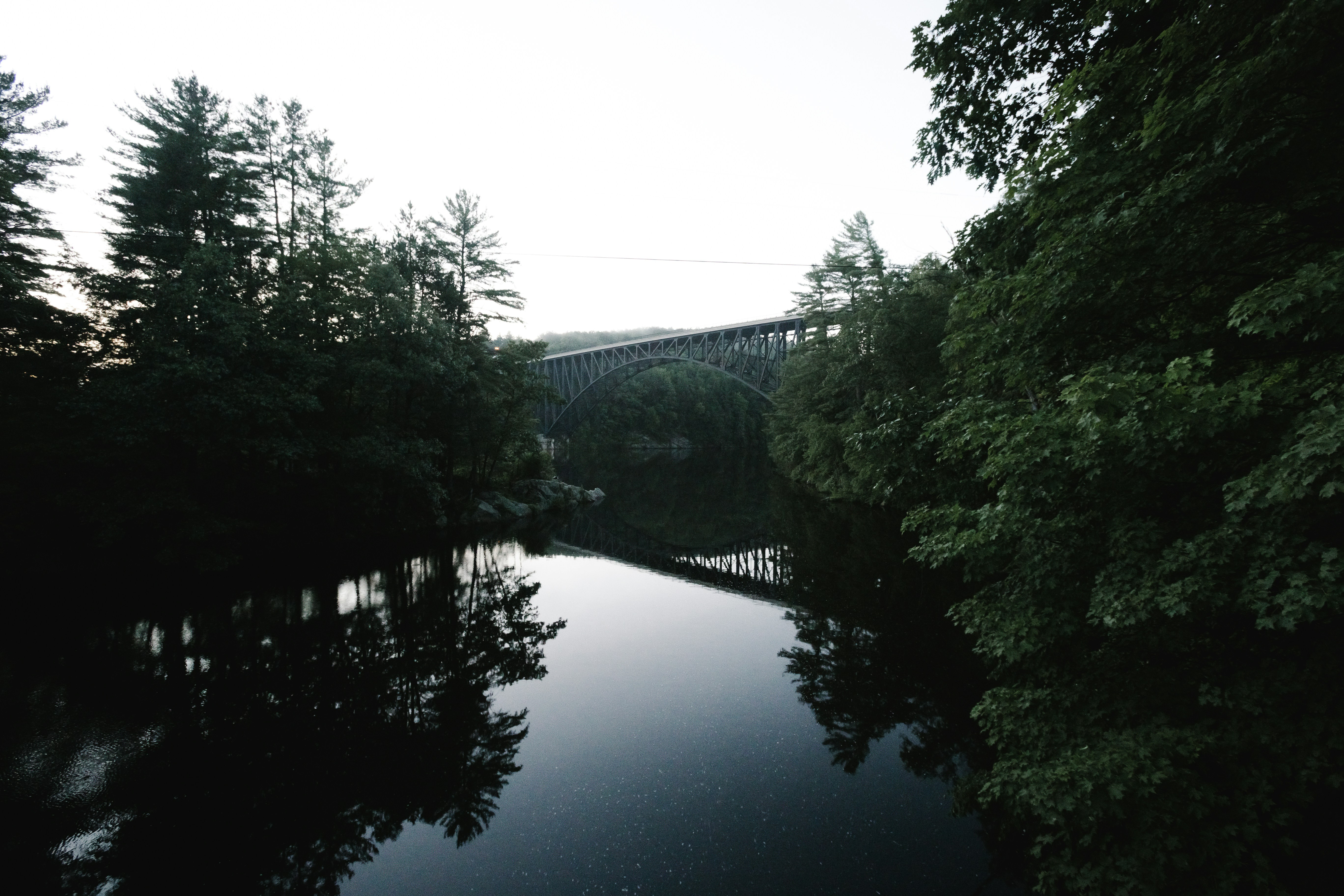 Bridge over still water: a symmetrical dusk scene