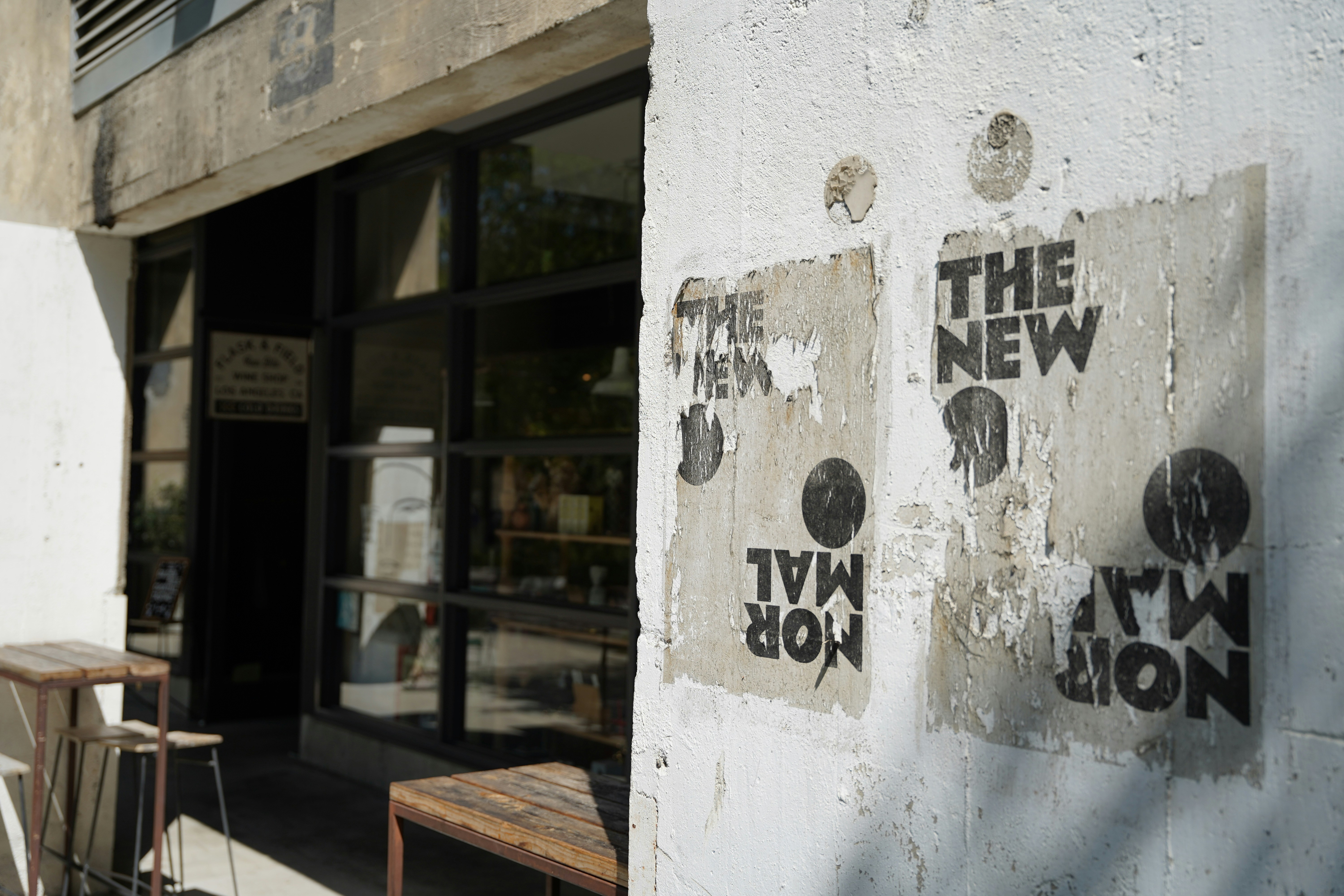 Weathered mural at the cafe doorway: The New Mural Revealed