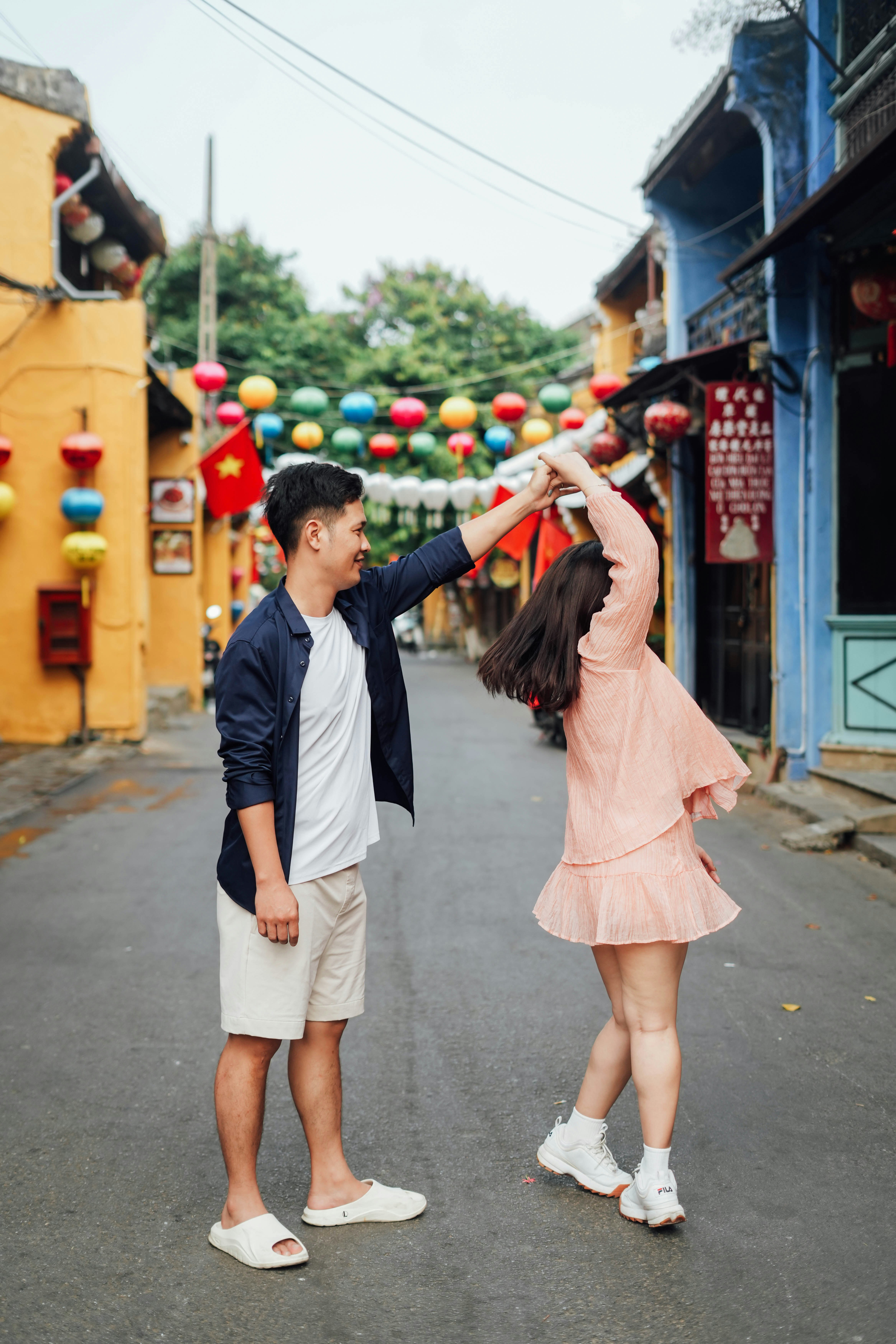 Street Serenade: A Couple Dancing Under Lanterns in a Colorful Lane