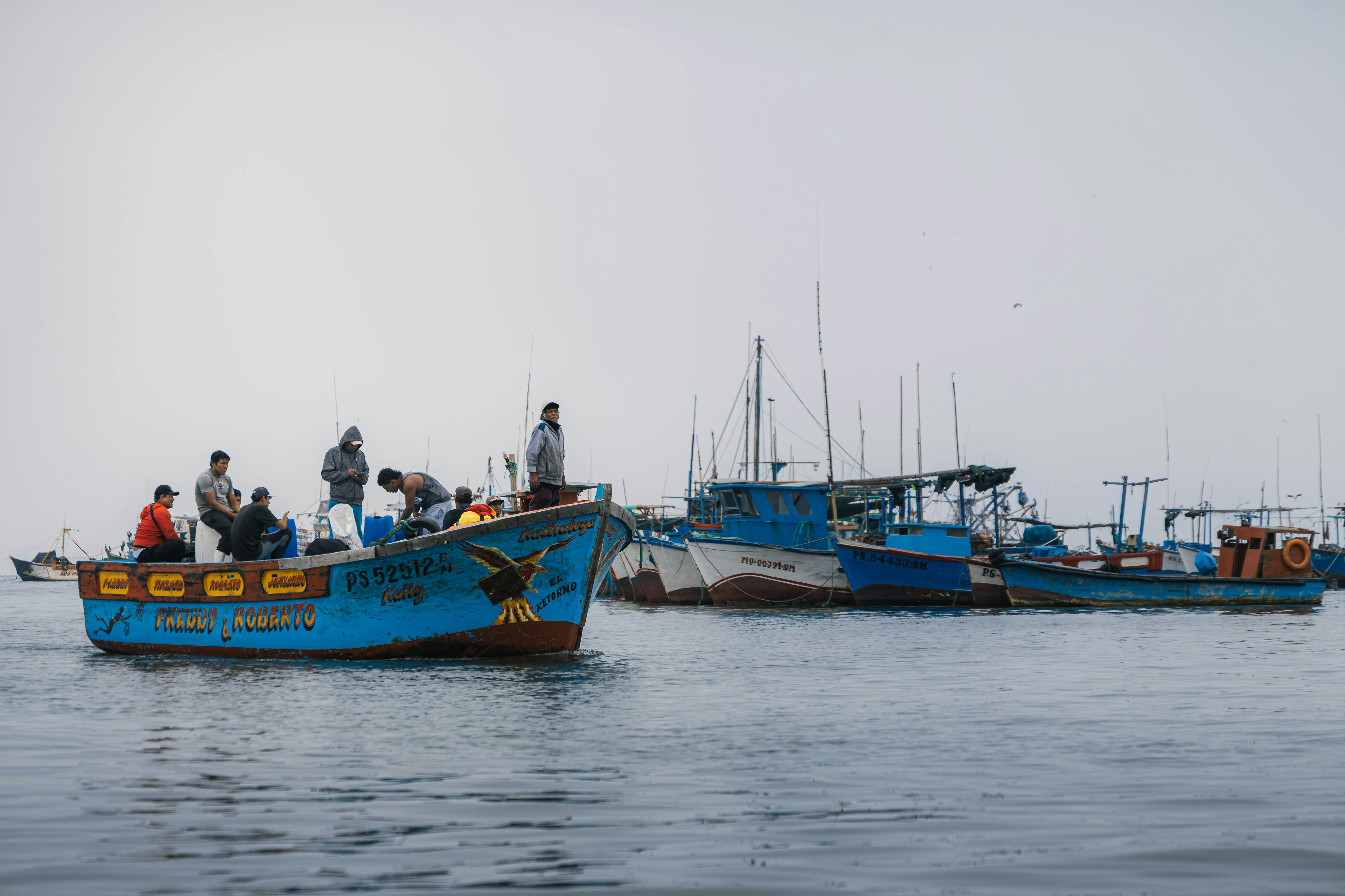 Blue Boat Rendezvous: A Fleet Anchored at Dusk