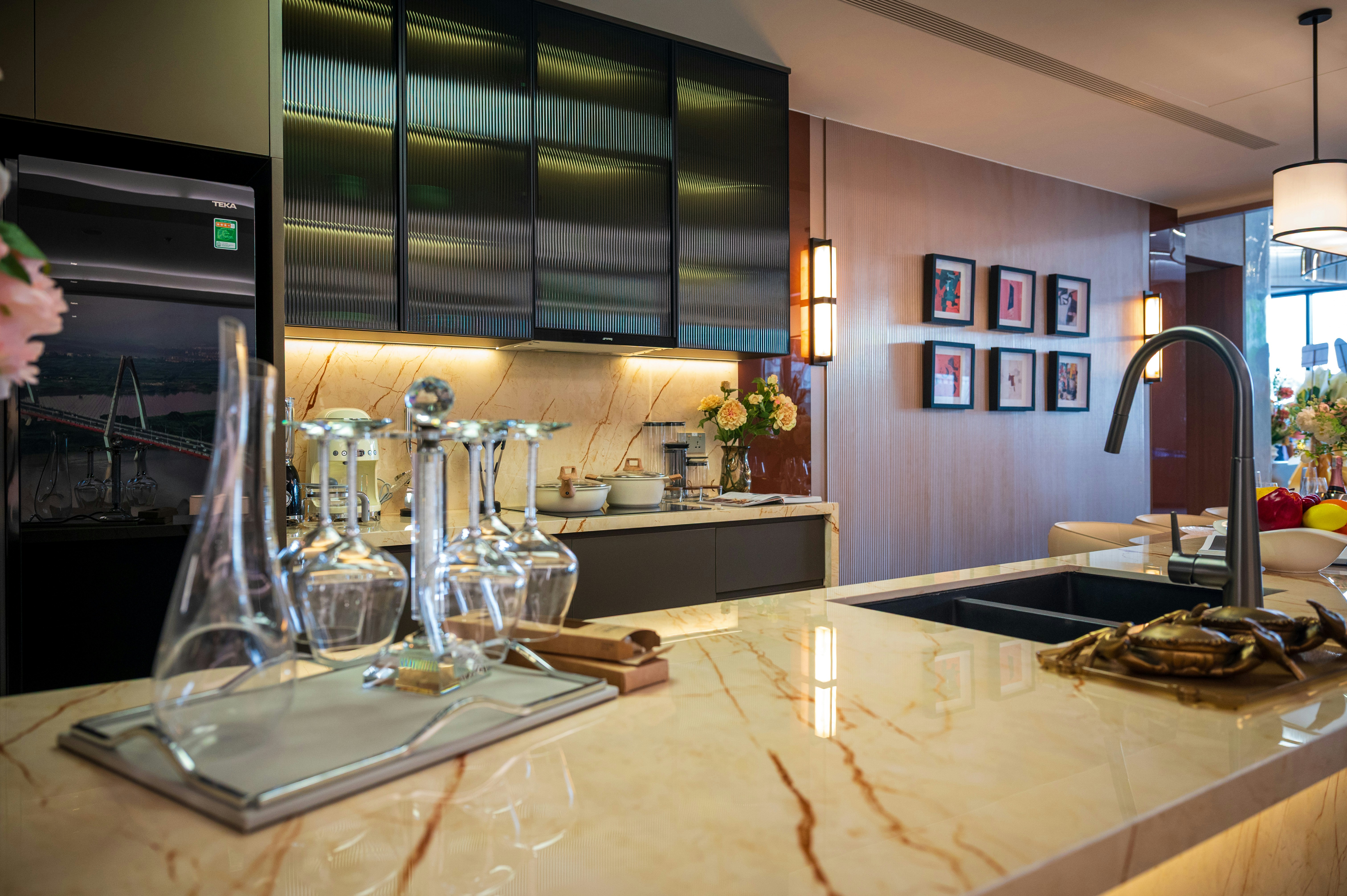 Marble Counter, Soft Lighting, and Glassware in a Contemporary Kitchen