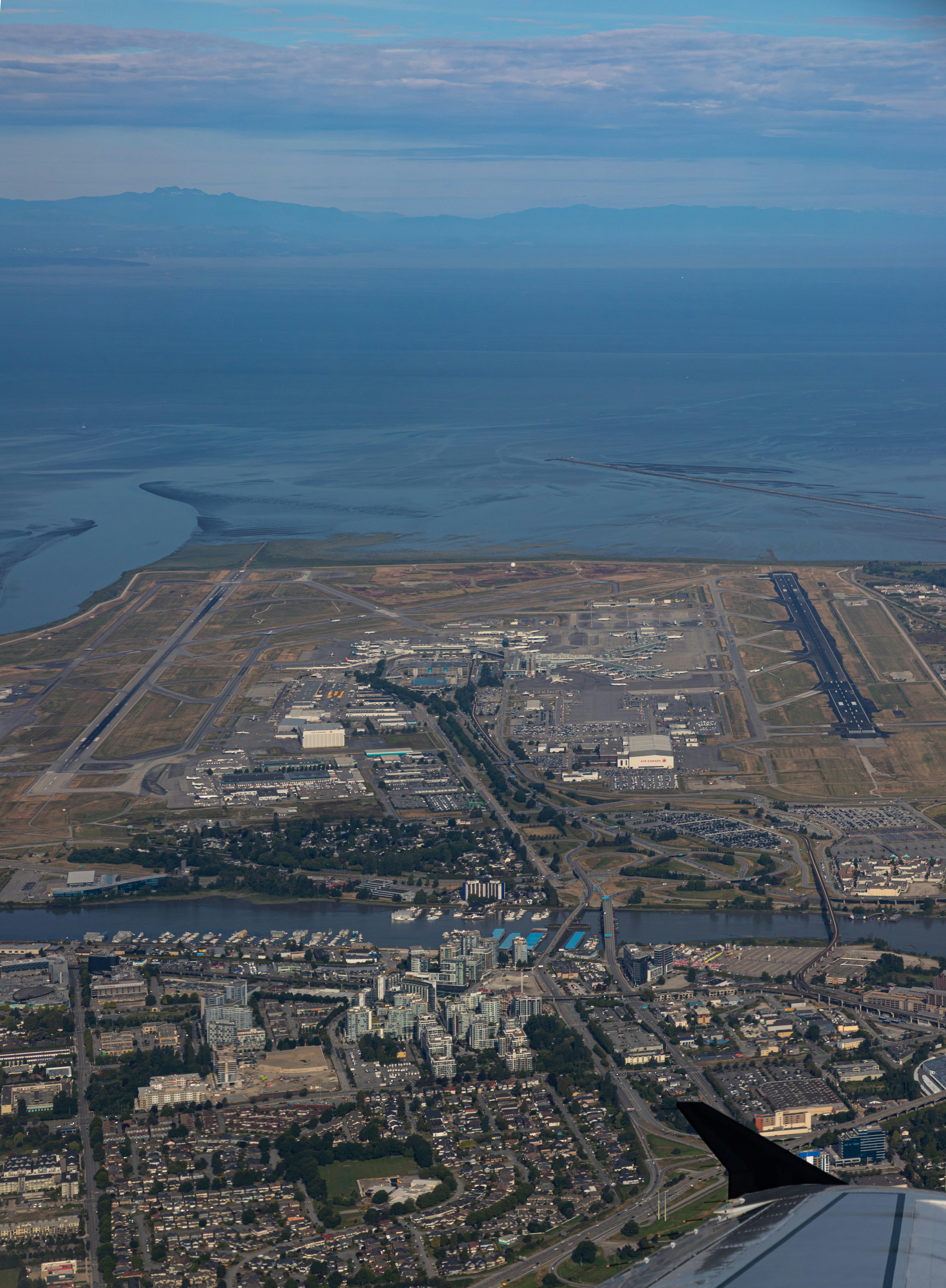 Overflight Over a Coastal Airport: Urban Grid Meets Blue Horizon