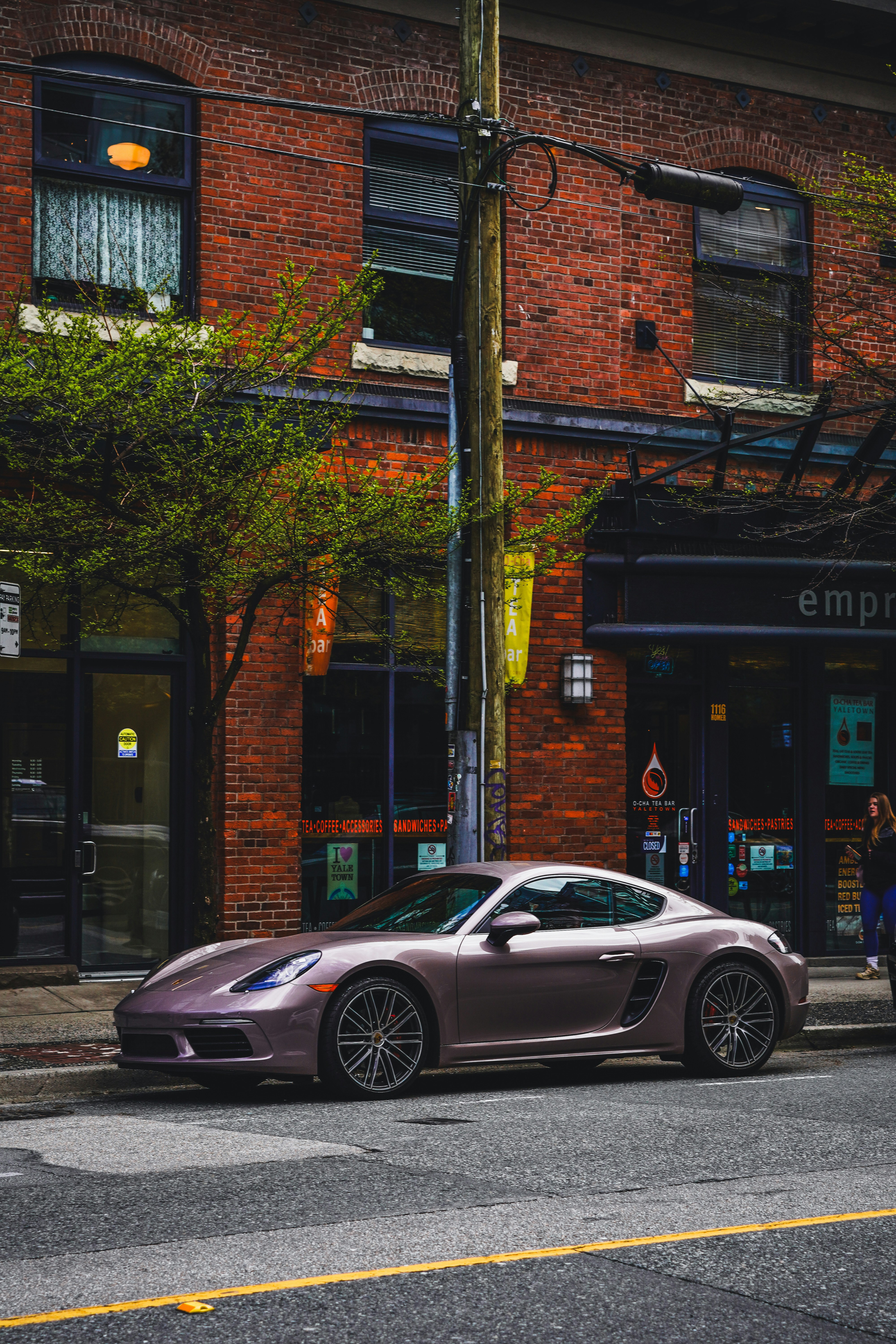 Lavender Roller: A Violet Porsche Graces a Brick-Hub Street
