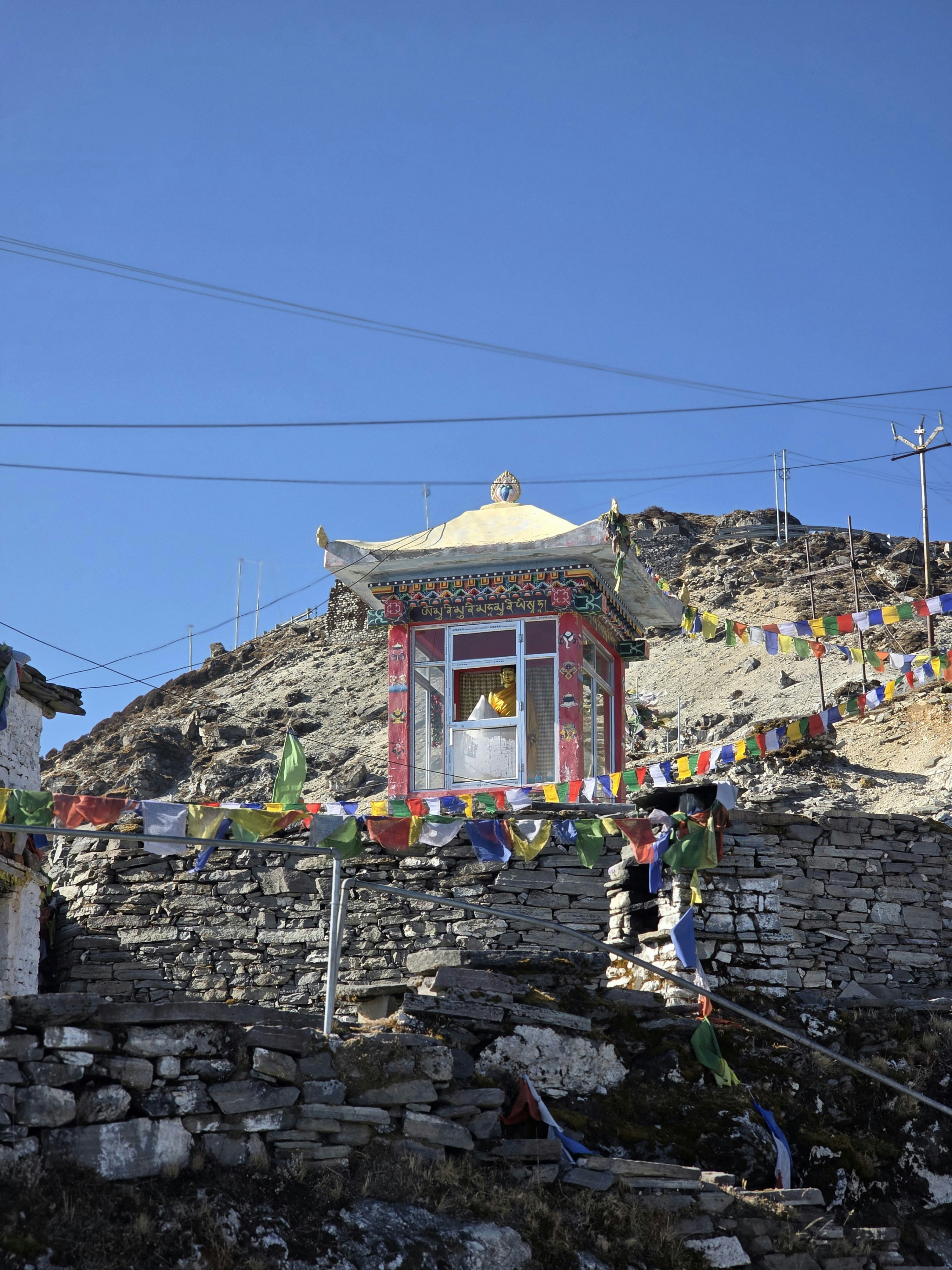 Prayer Flag Shrine: Stone Terrace and Mountain Backdrop