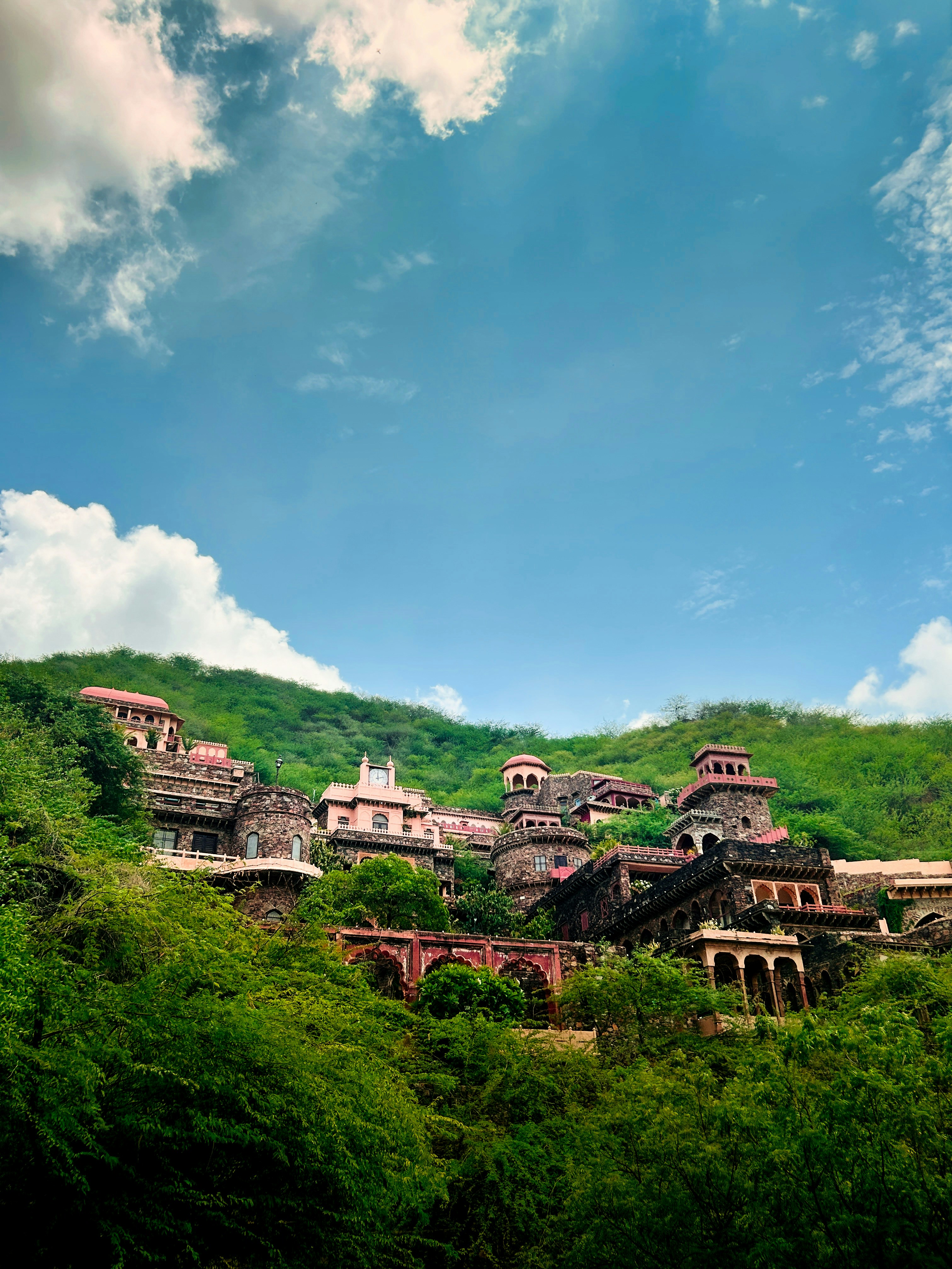 Hilltop Fortress Relics: Pink Domes Amid Green Slopes