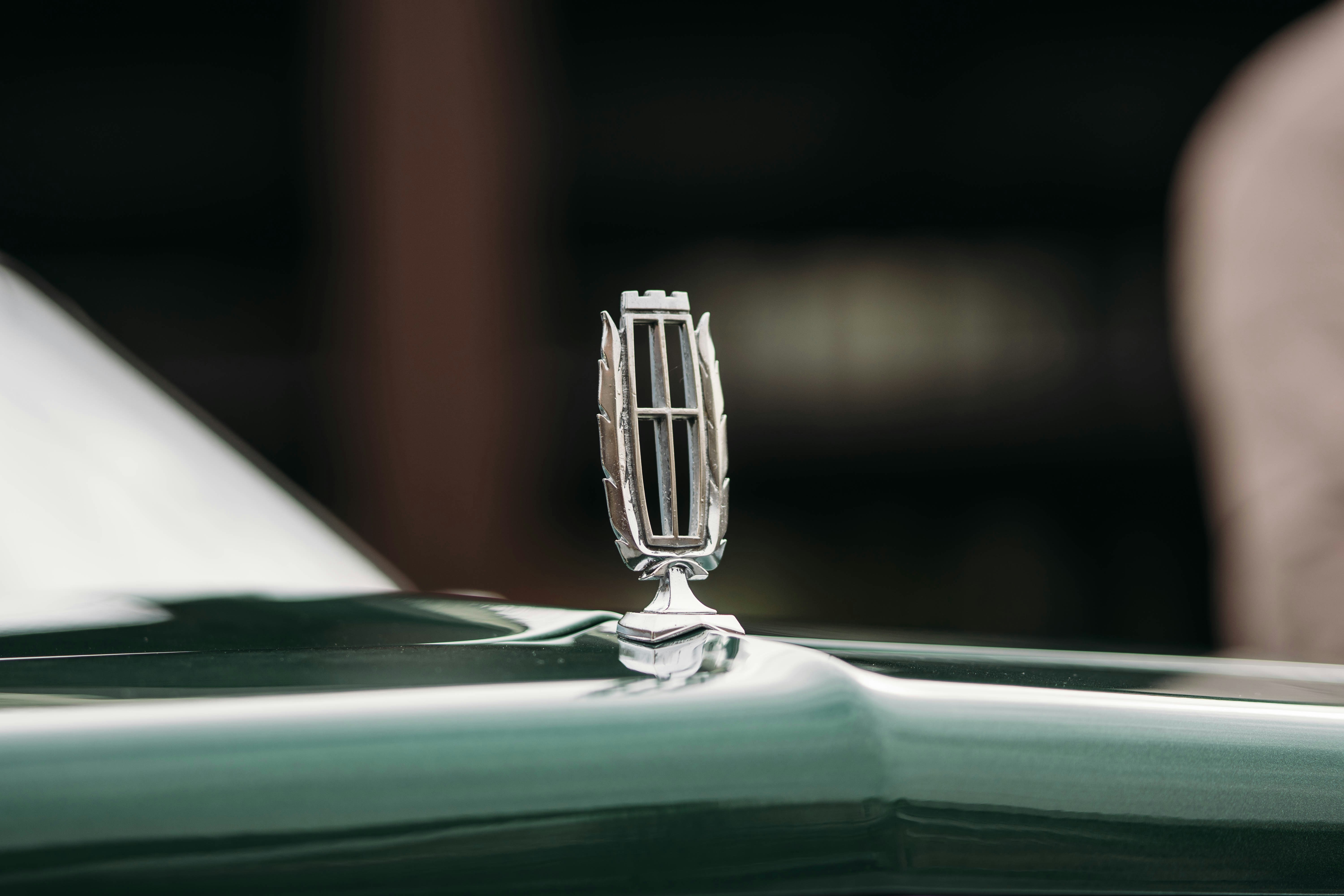 Hood Ornament on a Sparse Open Car Hood